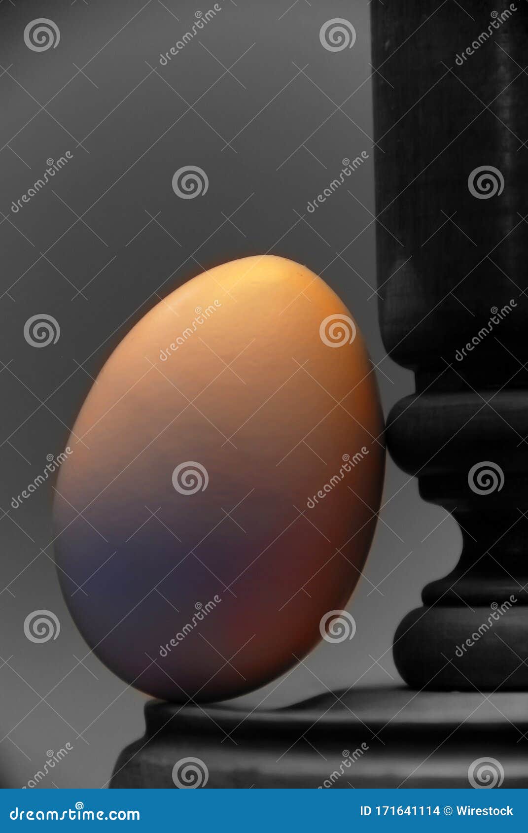 Closeup Shot of an Egg Tilted Towards a Black Structure Stock Photo ...
