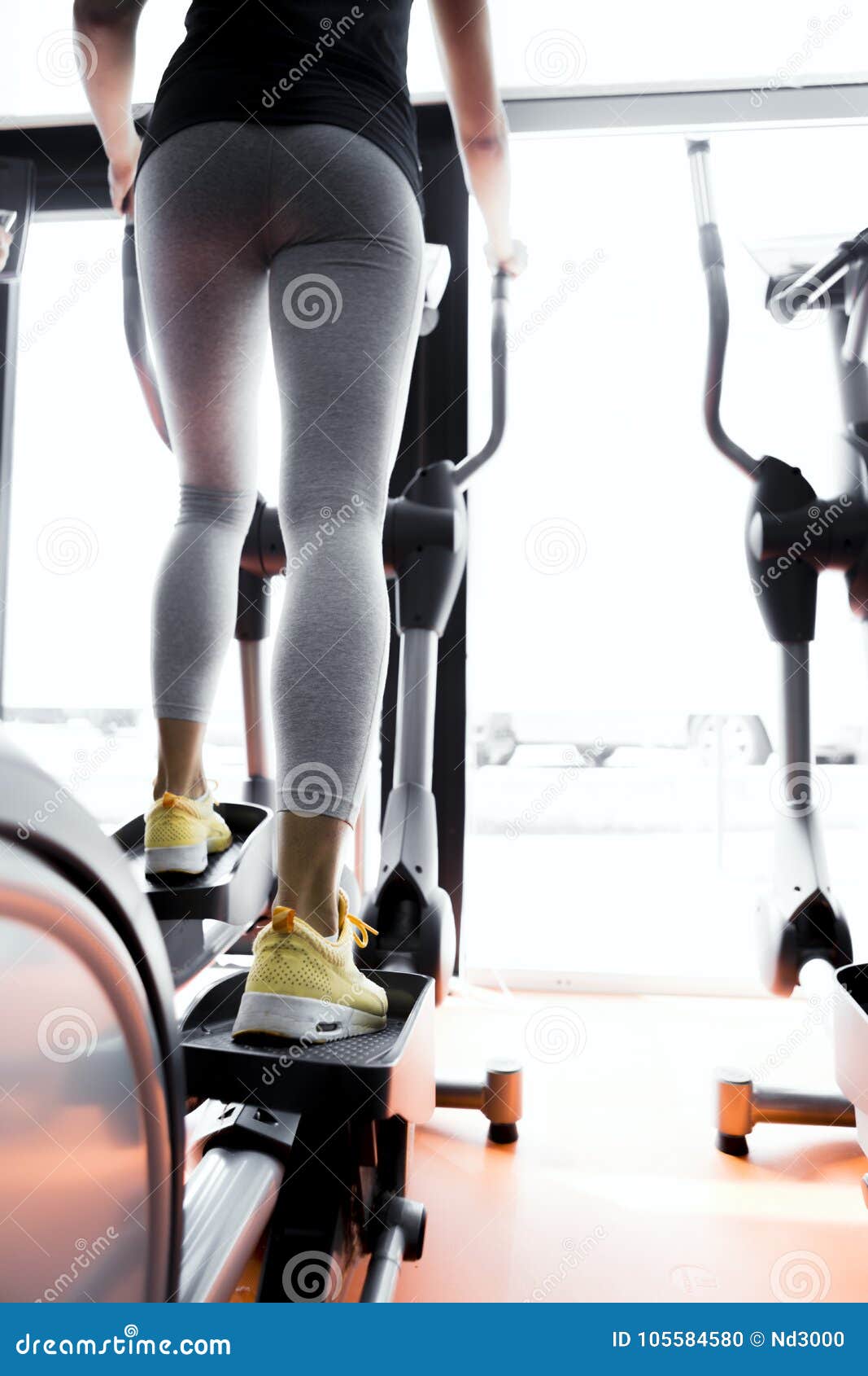 Closeup Shot of Legs of a Female Using Elliptical Trainer Stock Photo ...