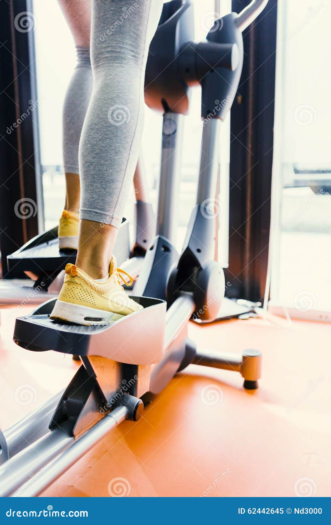 Closeup Shot of Legs of a Female Using Elliptical Trainer Stock Image ...