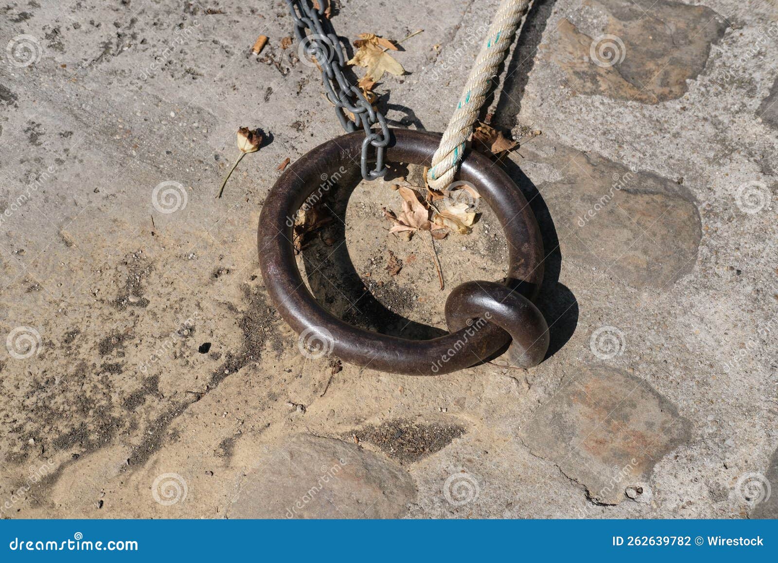 Closeup Shot of a Loop Ring Placed on the Ground with Chains and Ropes ...