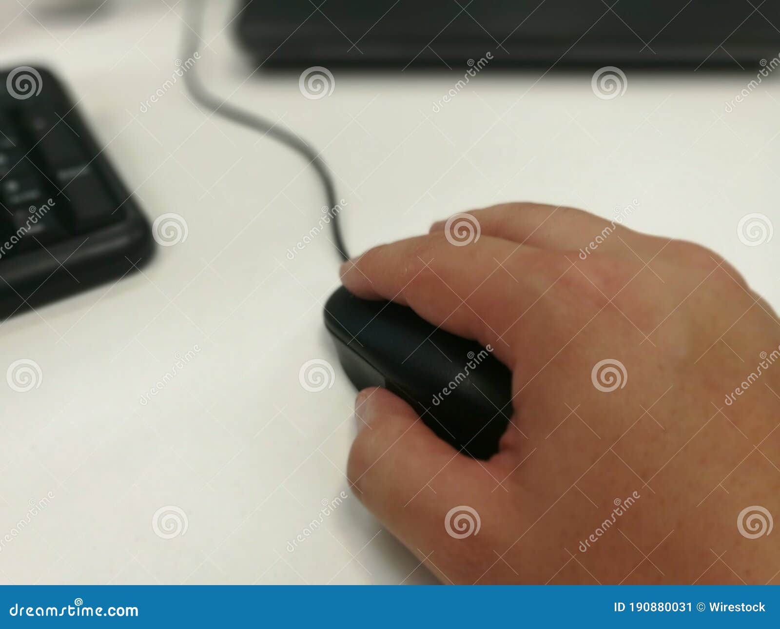 Closeup Shot of a Male Hand Holding a Computer Mouse Next To a Black ...