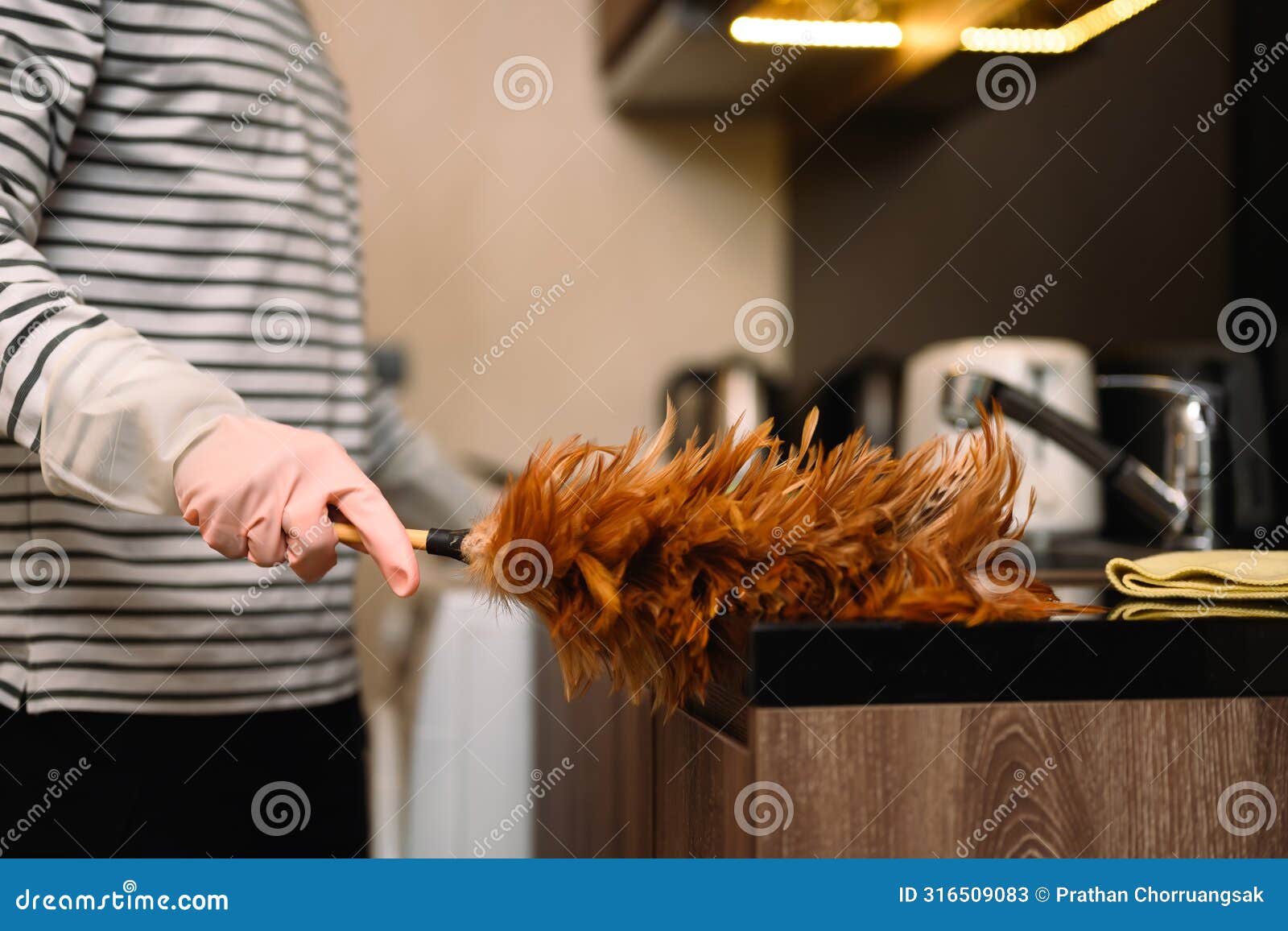 Closeup Shot of Man Dusting Kitchen with a Feather Duster. Housekeeping ...
