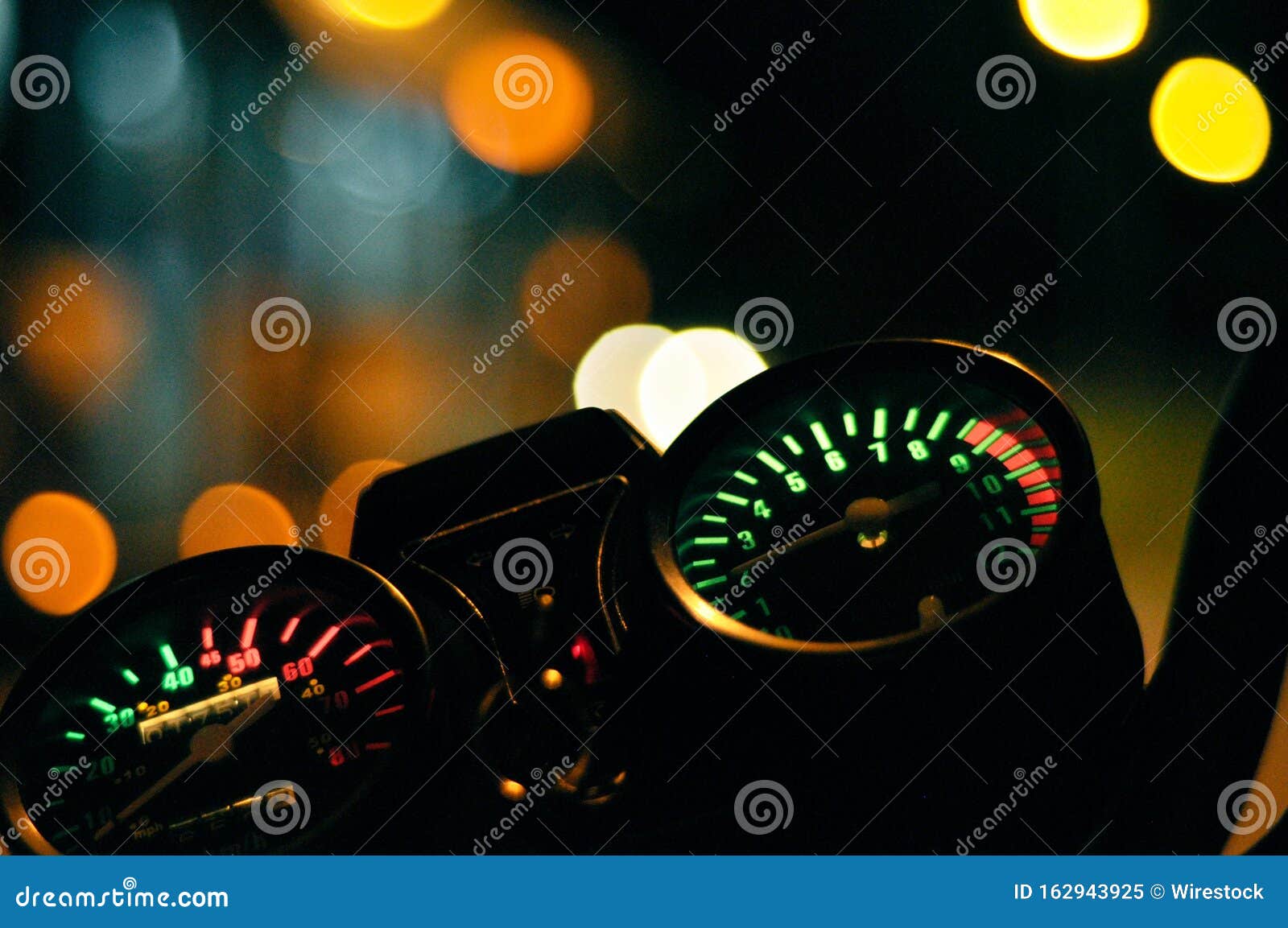 Closeup Shot of the Odometer of a Motorcycle with Blurred Lights in the ...