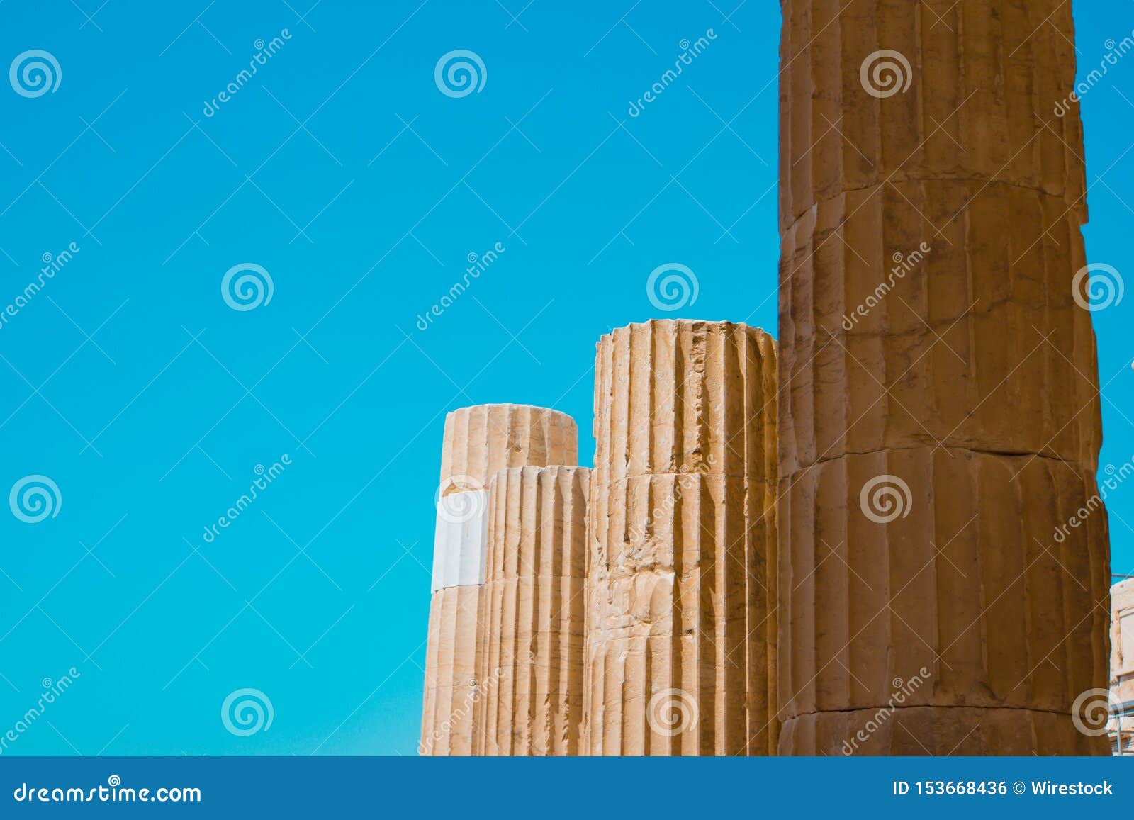 Closeup Shot of Old Damaged Stone Pillars with a Clear Blue Background ...