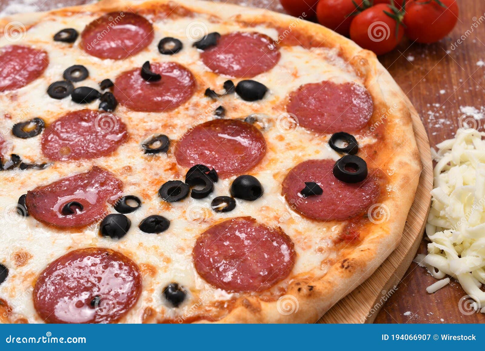 Closeup Shot of a Pepperoni Pizza with Olives on a Messy Kitchen Table ...