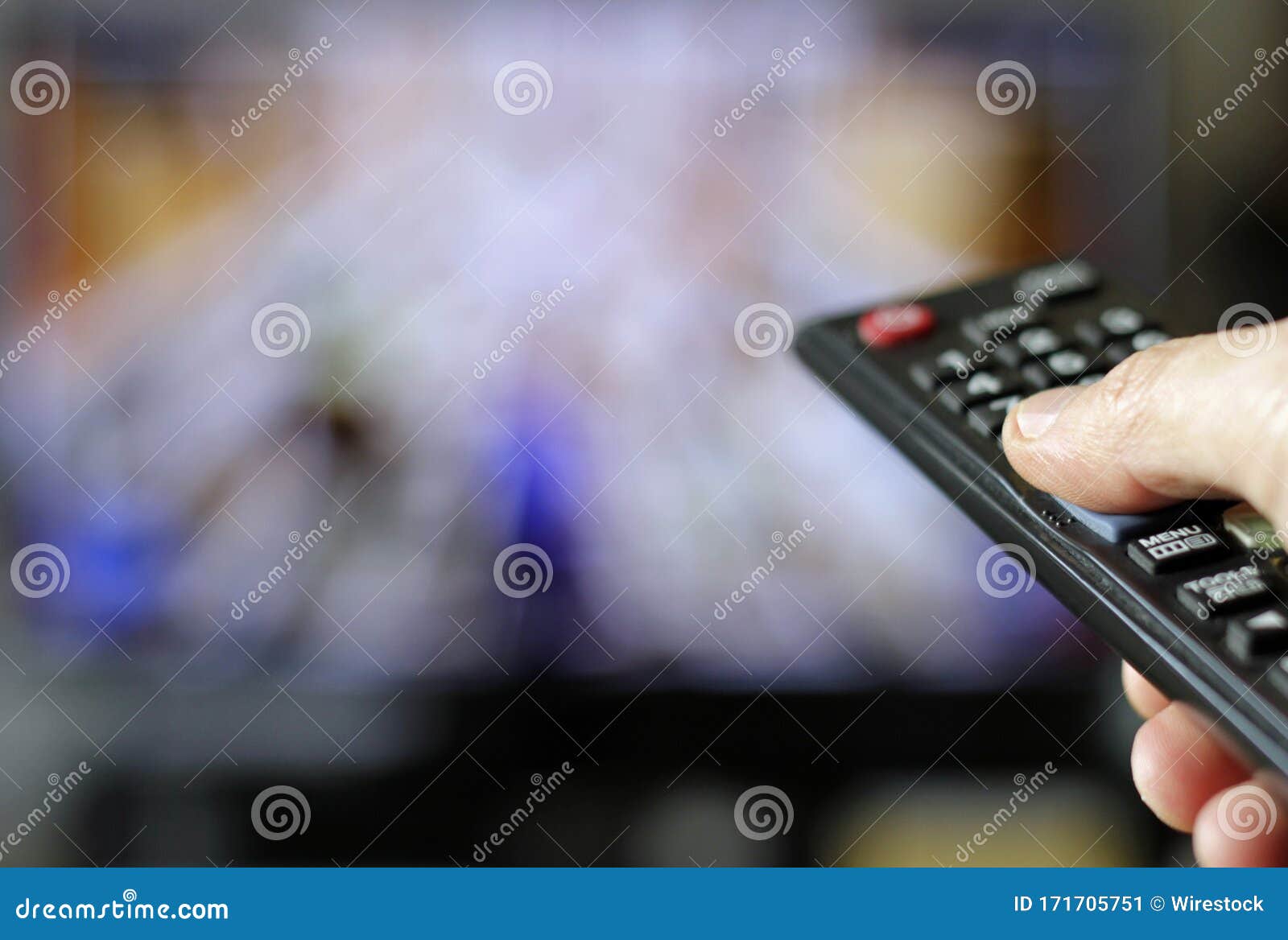 Closeup Shot of a Person Using the Television Remote To Change the ...