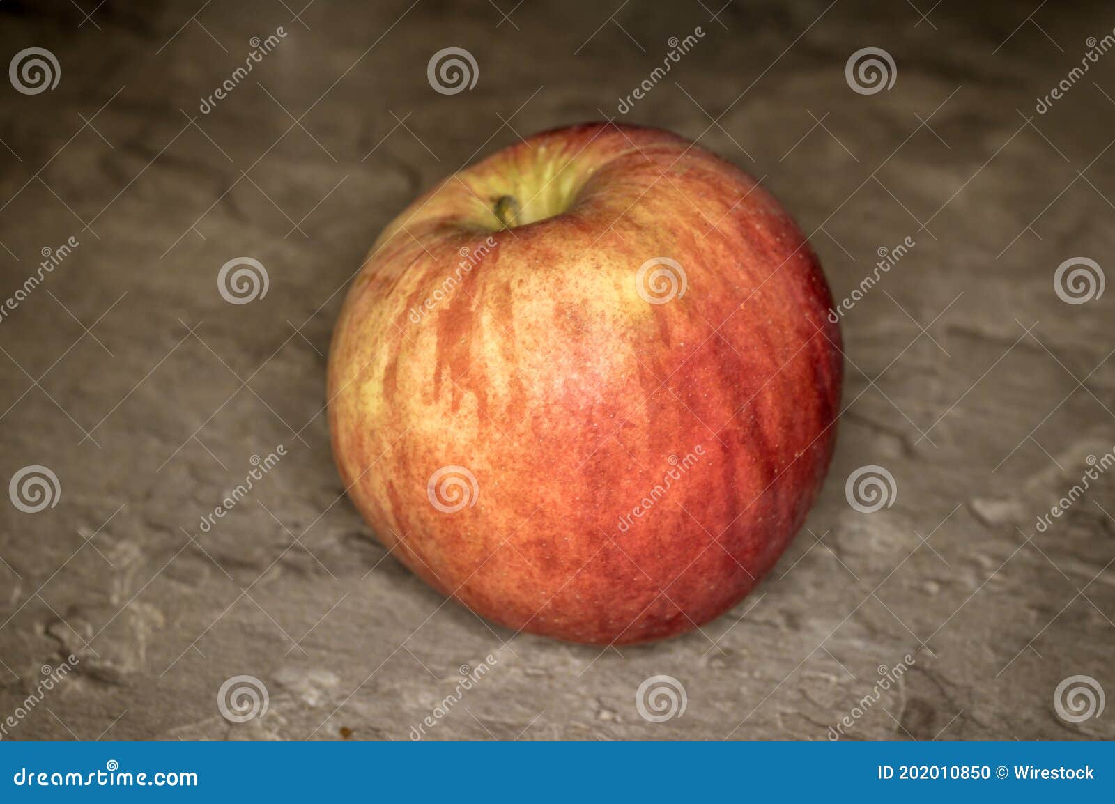Closeup Shot of a Red Apple on the Ground Surface Stock Photo - Image ...