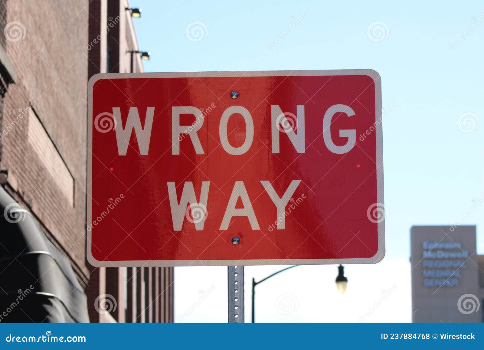 Closeup Shot of a Red Sign with a "Wrong Way" Writing Stock Photo ...