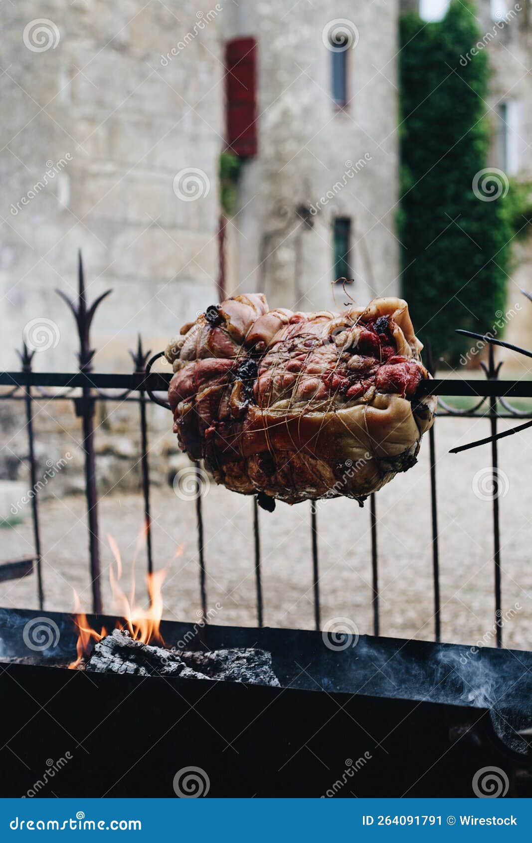 Closeup Shot of Roasting Meat on a Spit with Fire on the Background ...