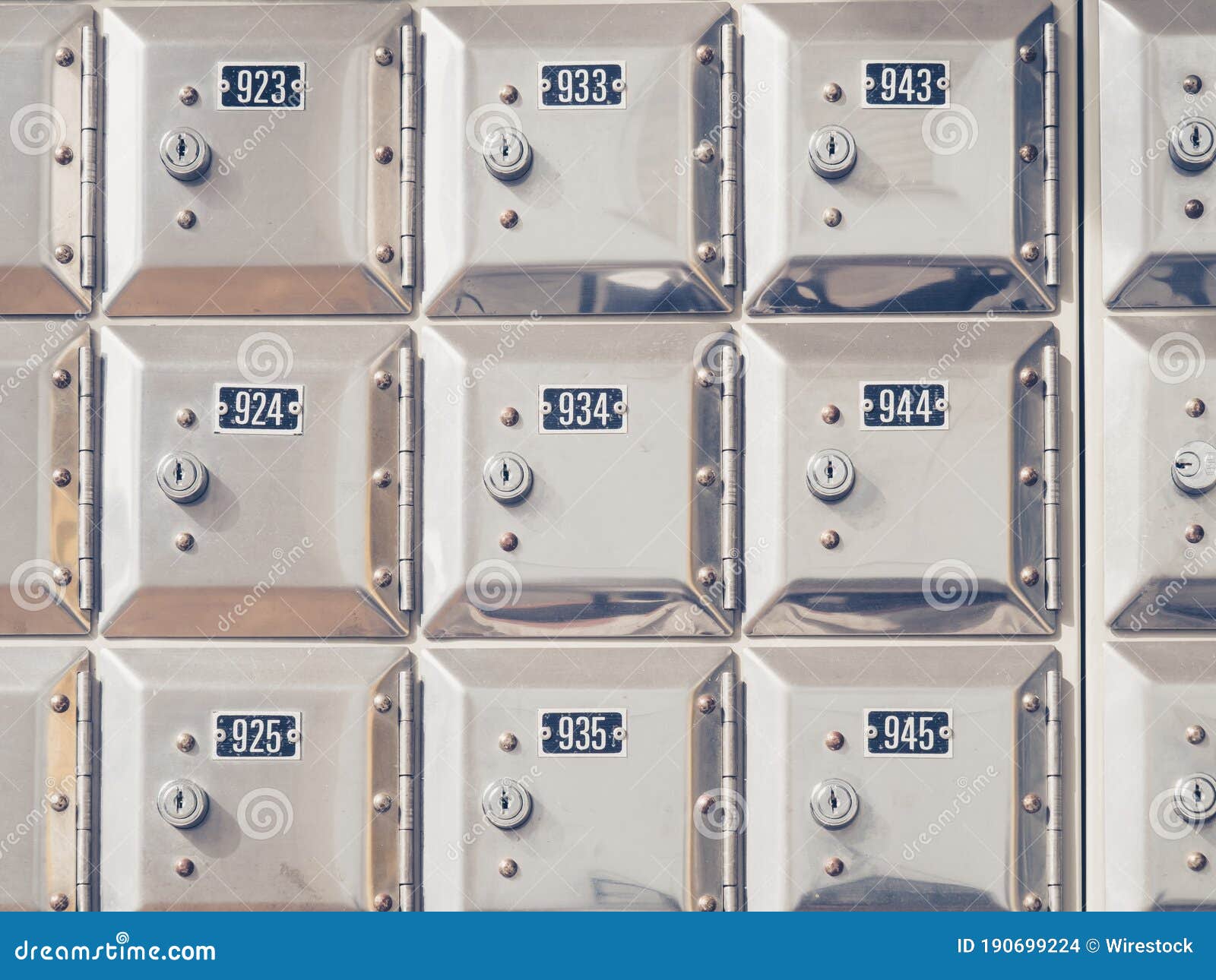 Closeup Shot of Rows of Small Silver Numbered Lockers Stock Photo ...