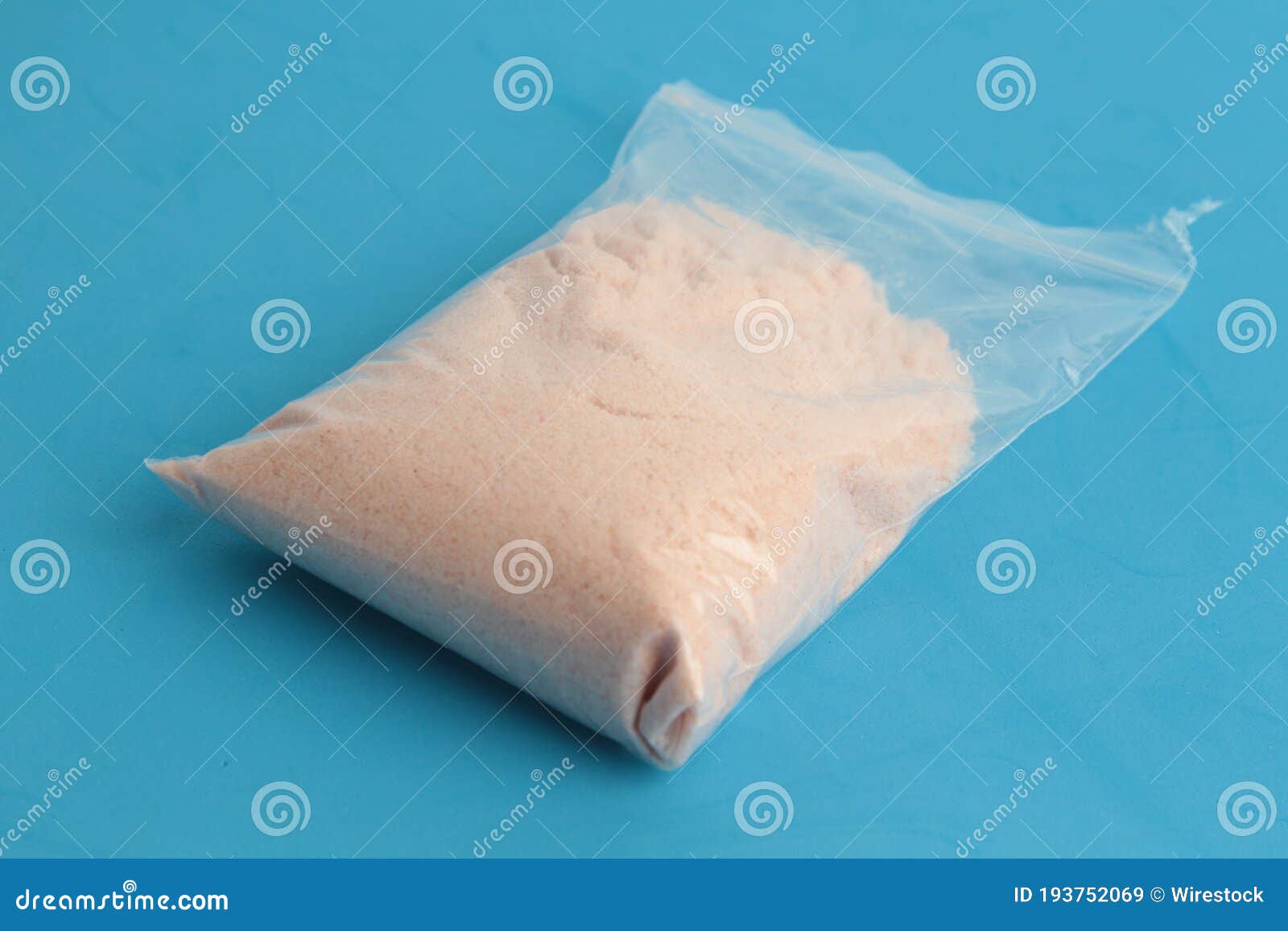 Closeup Shot of Sand in a Plastic Bag on a Blue Surface Stock Image ...