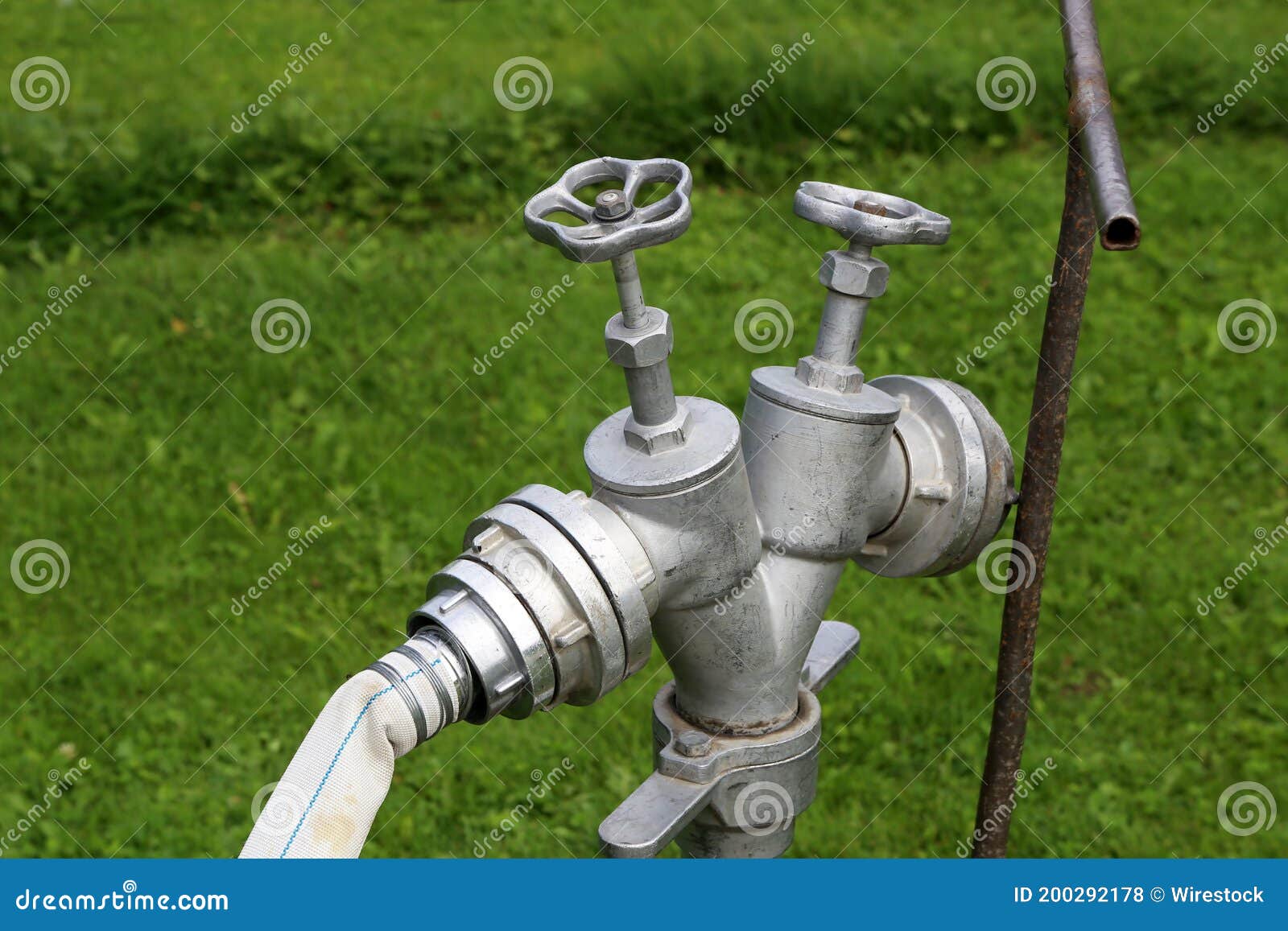 Closeup Shot of a Silver Fire Hydrant with a Hose Stock Photo - Image ...