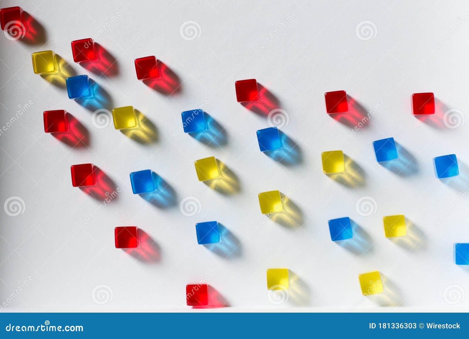 Closeup Shot of Small Red, Blue, and Yellow Square Crystals on a Grey ...