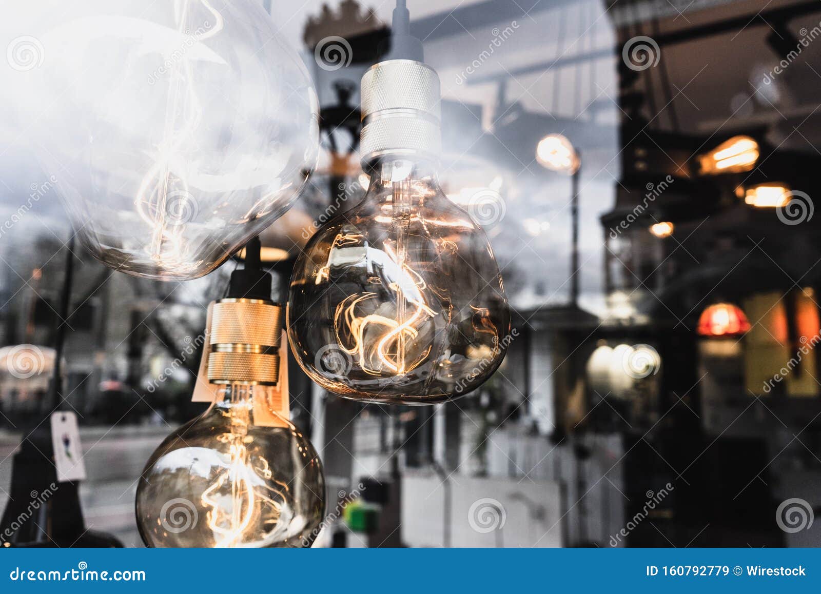 Closeup Shot of Three Turned on Edison Lightbulbs Behind Glass Inside a ...
