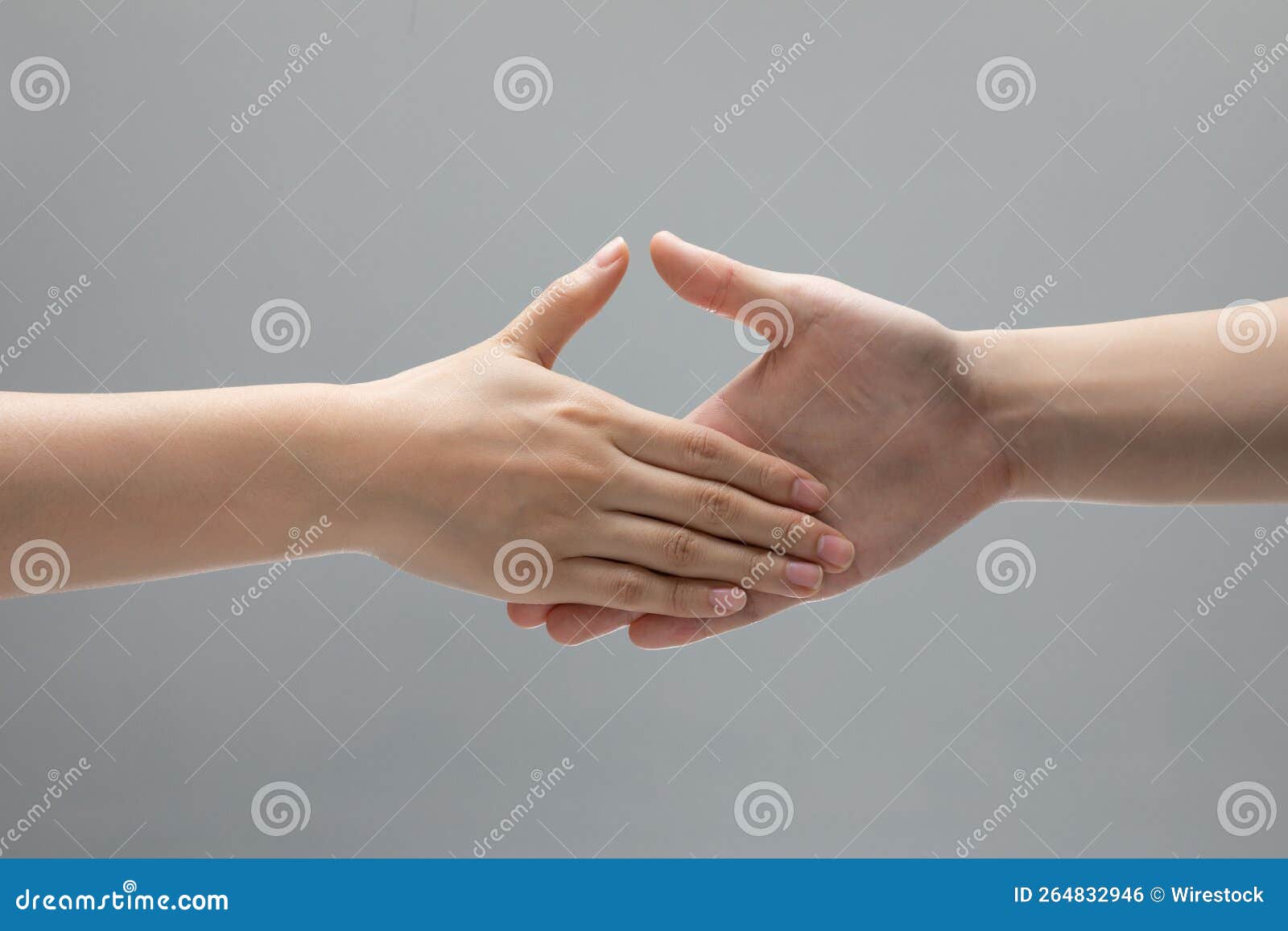Closeup Shot of Two Helping Hands Touching in Front of a Gray ...