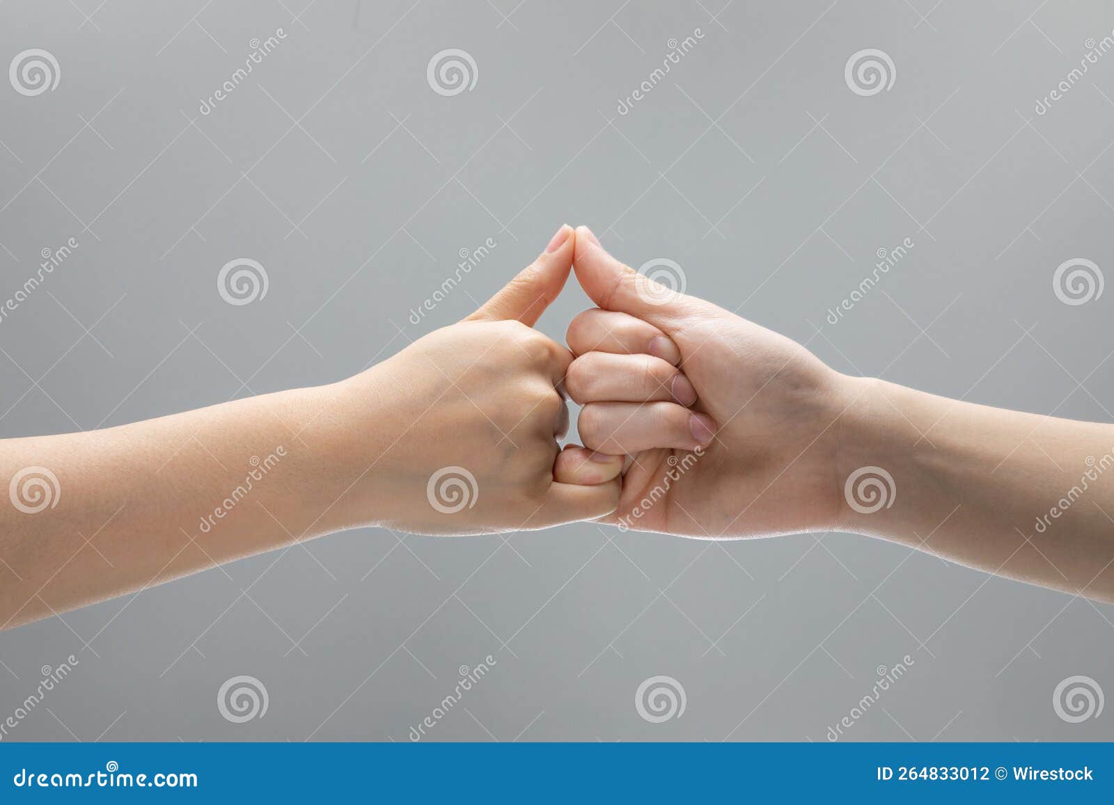 Closeup Shot of Two Helping Hands Touching in Front of a Gray ...