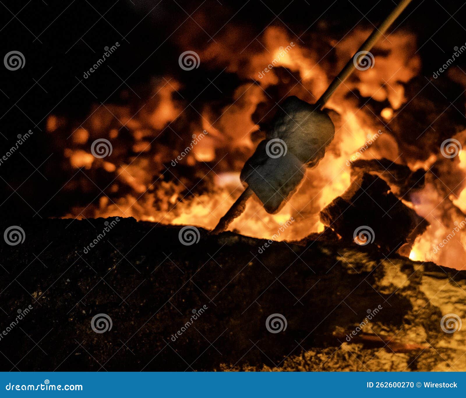 Closeup Shot of Two Roasting Marshmallows with Fireplace in the ...