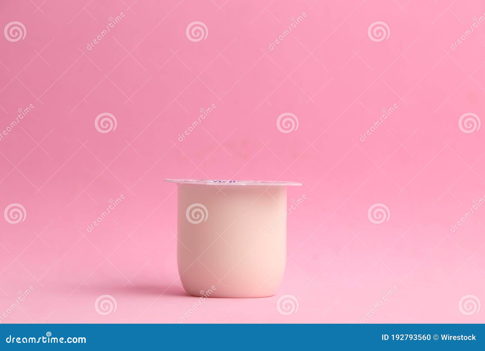 Closeup Shot of Yogurt in a White Plastic Cup Isolated on a Pink ...