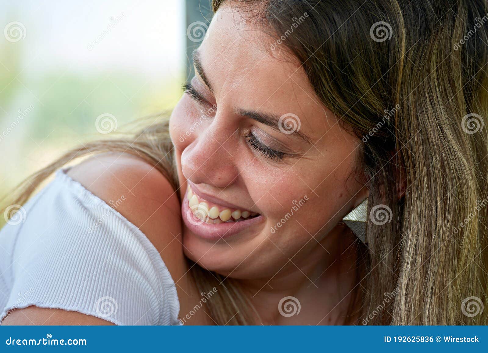 Closeup Shot of a Young Female Smiling and Looking Back Stock Photo ...