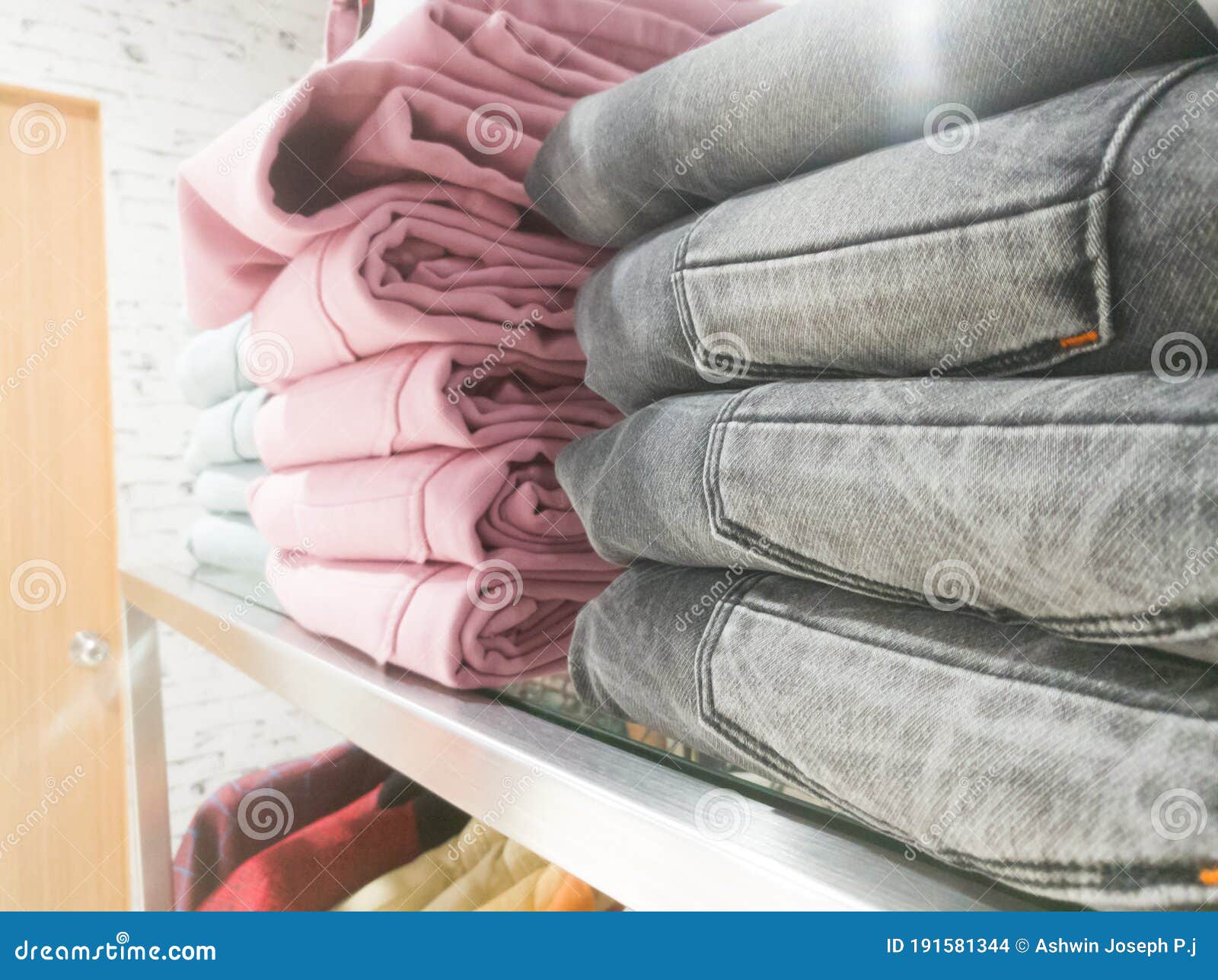 A Closeup Side Angle View of a Stack of Pants Placed on the Shelf Stock ...