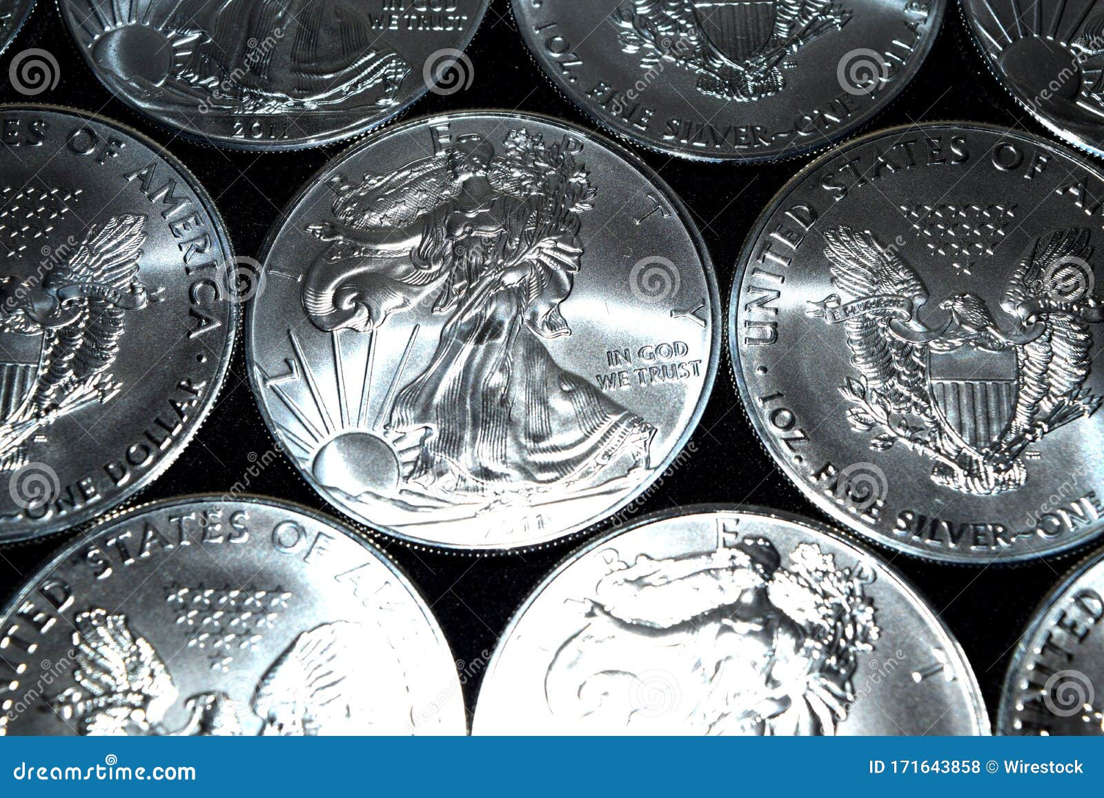 Closeup of Silver Coins Under the Lights Against a Black Background ...