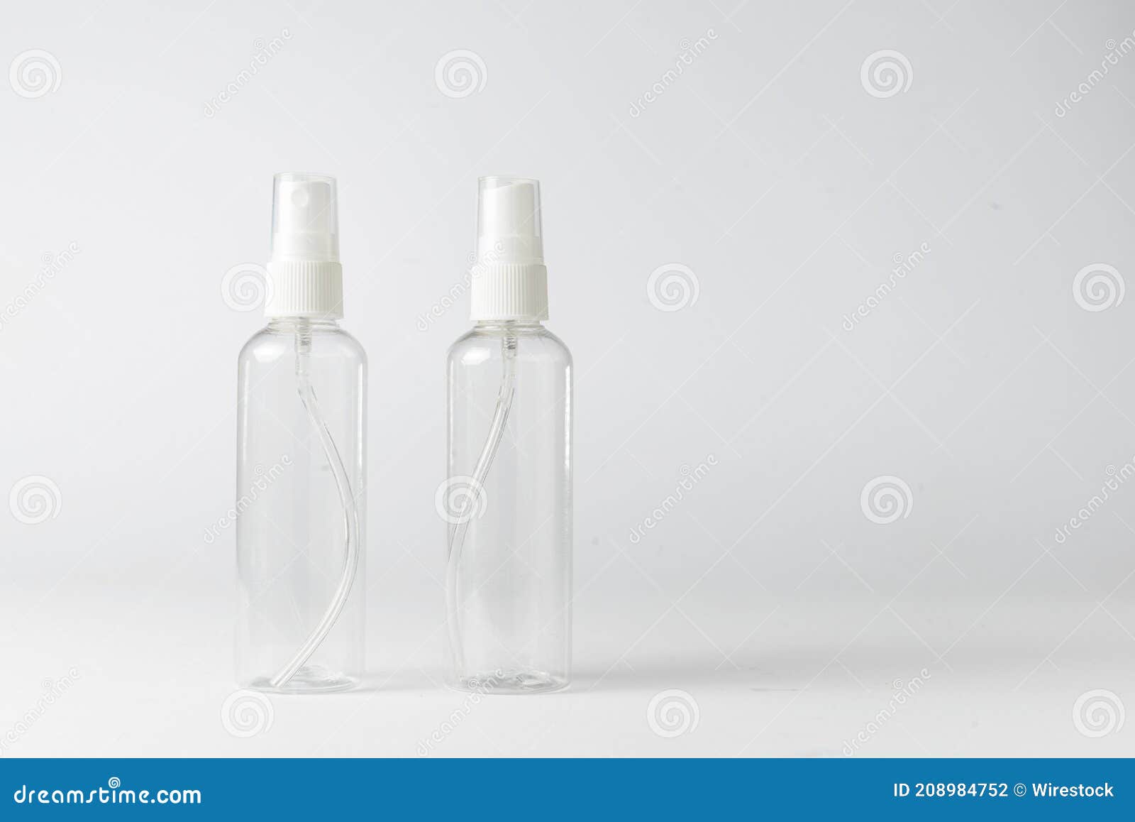 Closeup of Small Empty Spray Bottles Isolated on a Gray Background ...