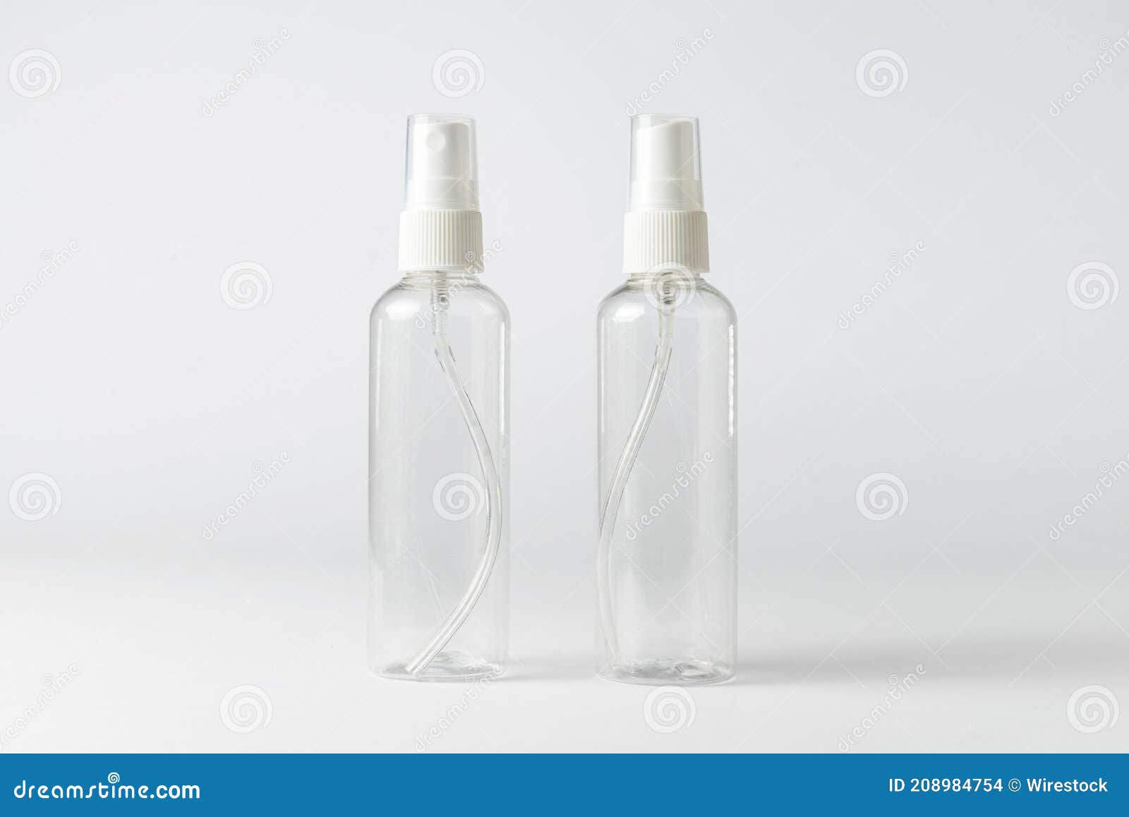 Closeup of Small Empty Spray Bottles Isolated on a Gray Background ...