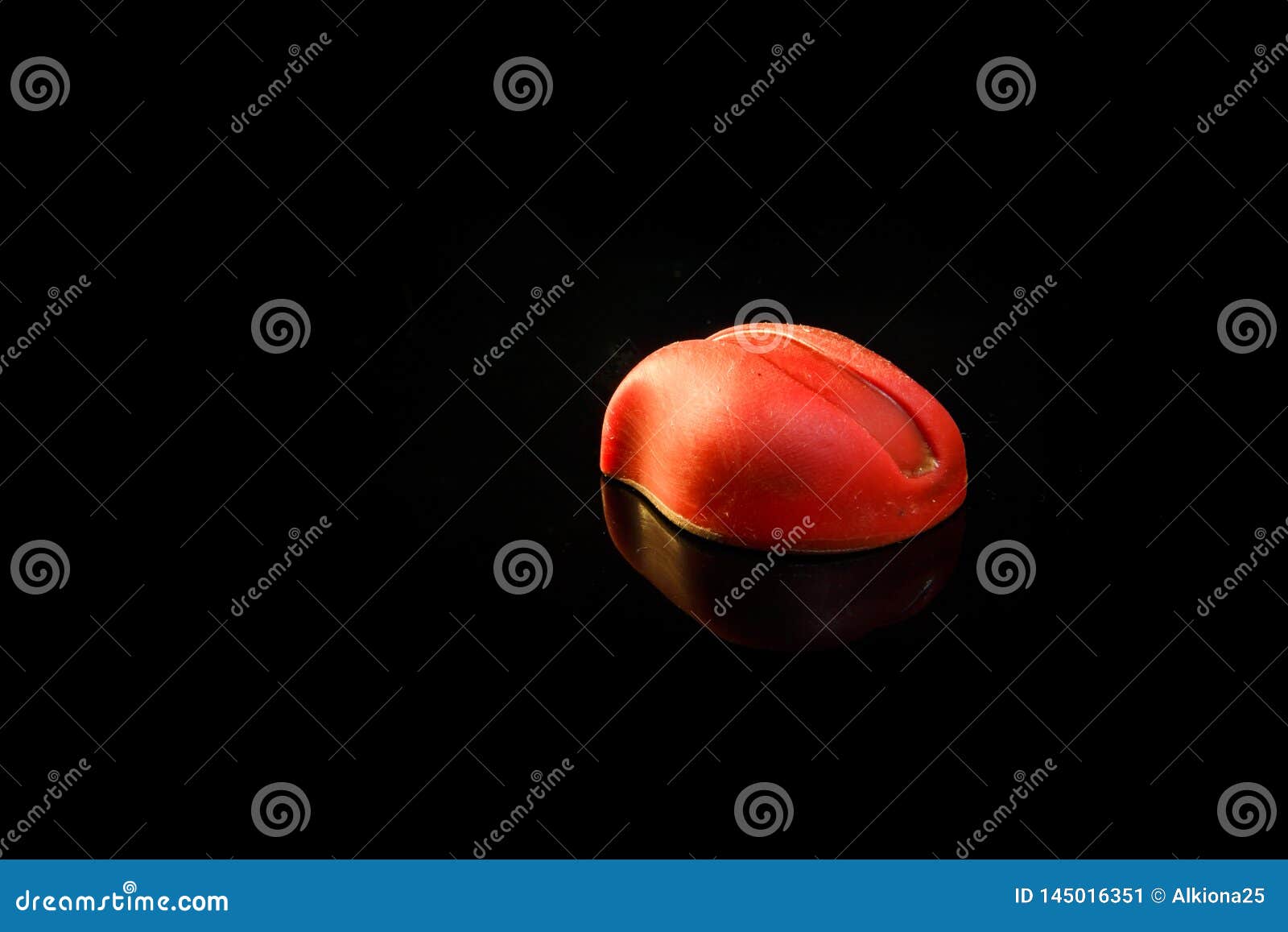 Closeup Small Red Oval-shaped Chocolate Candy with Reflection Stock ...