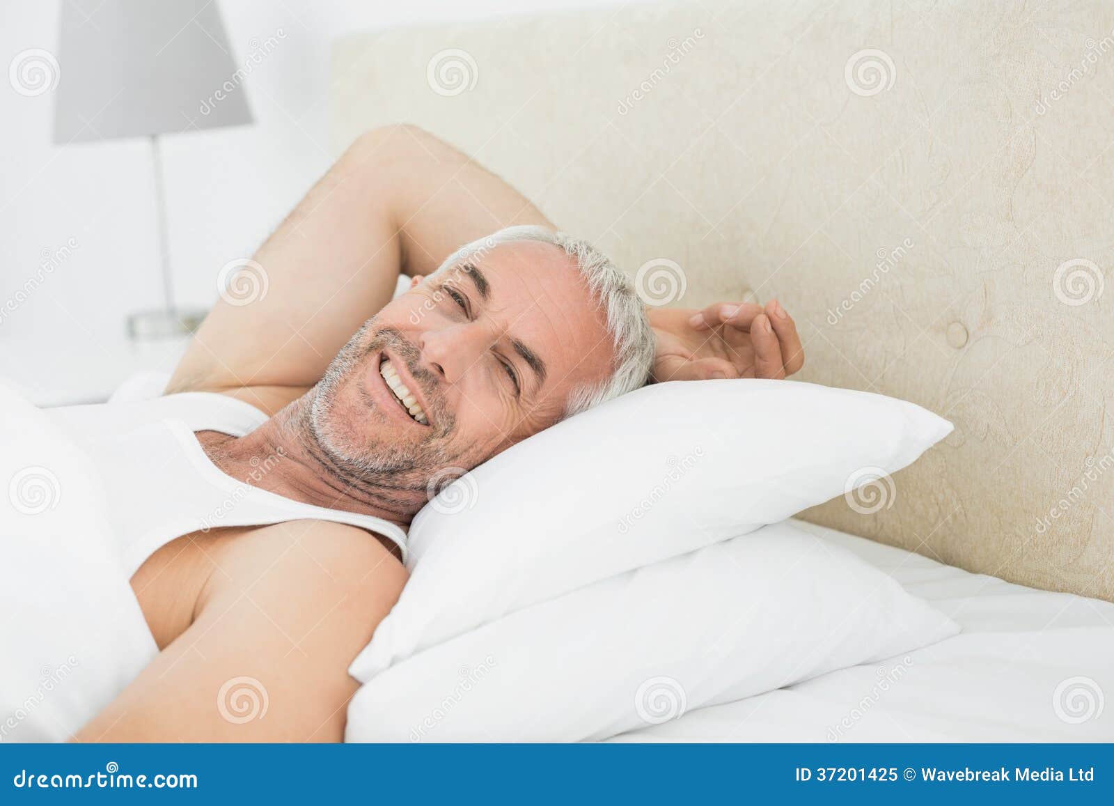 Closeup of a Smiling Mature Man Resting in Bed Stock Image - Image of ...