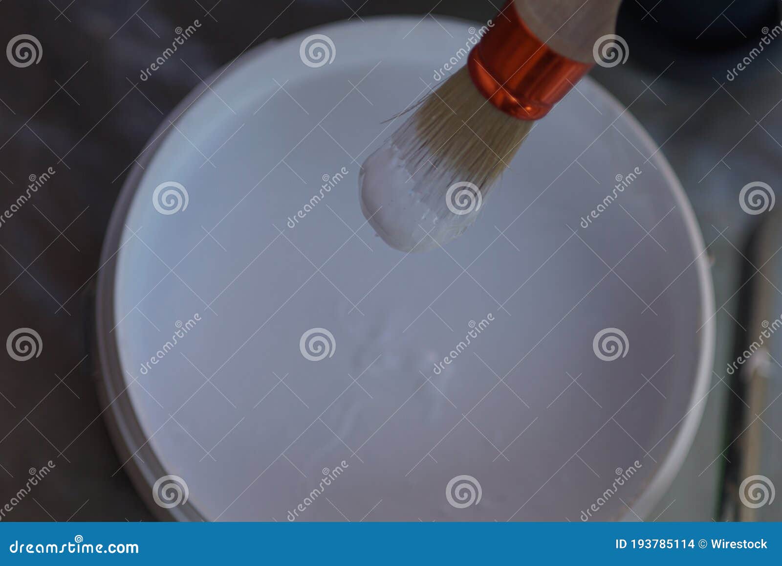 Closeup of Someone Dipping the Paintbrush in the White-colored Paint ...