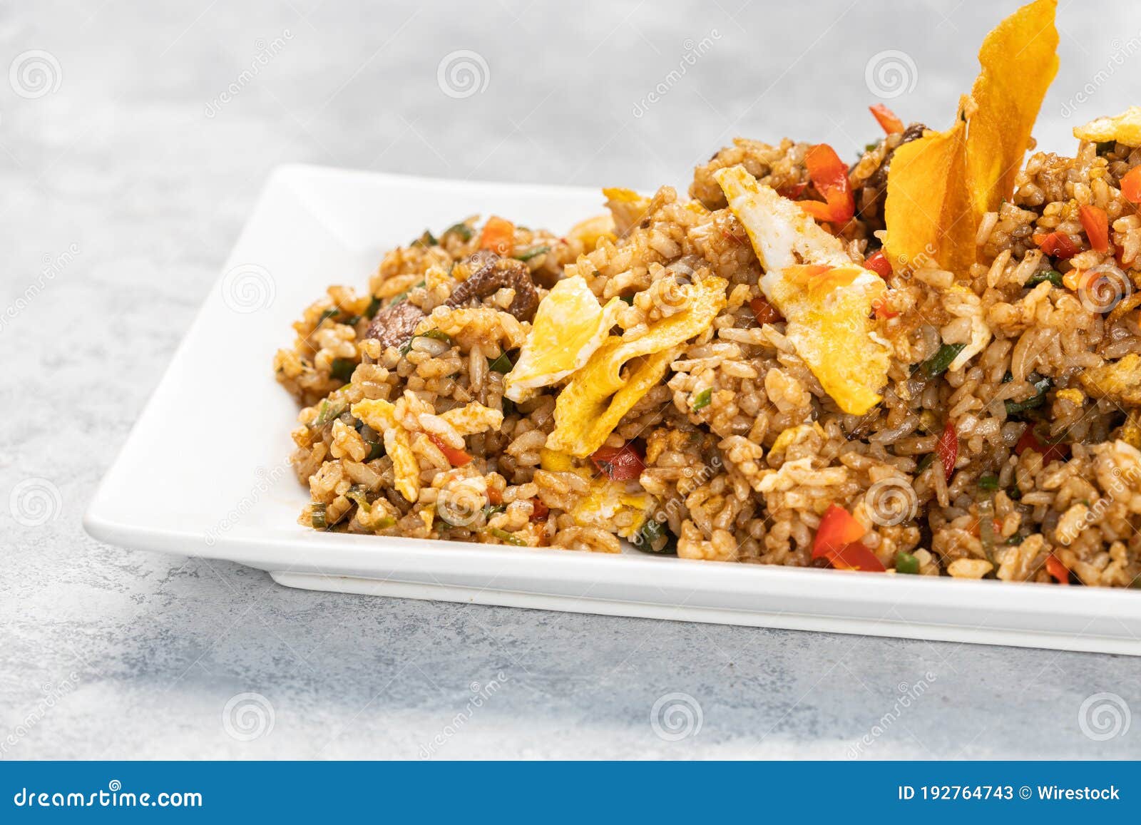 Closeup of Spicy Cooked Rice with Meat, Vegetables and Chips in a Plate ...
