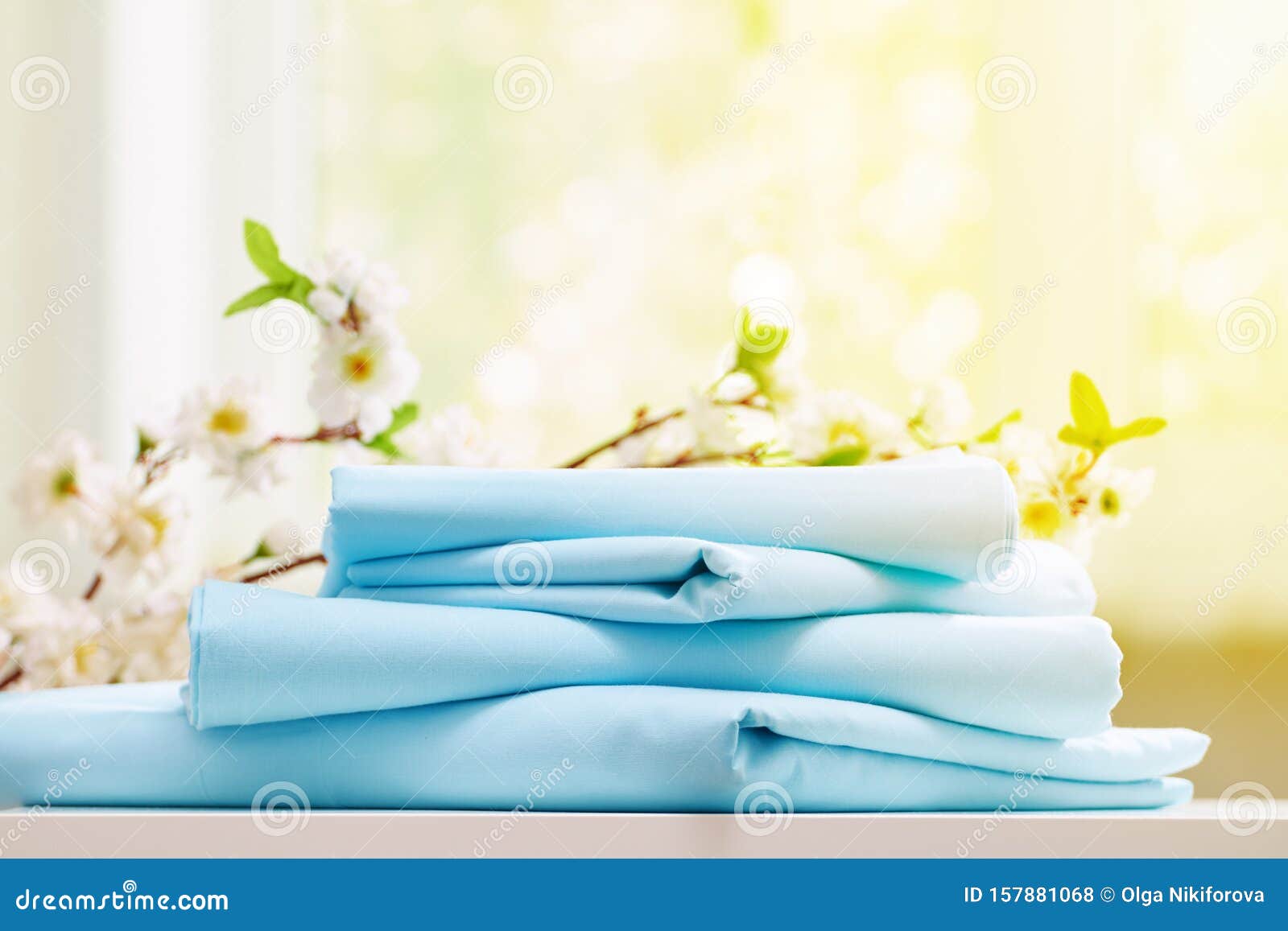 Closeup Stack of Blue Clean Bedding on a Dresser. Blurred Background ... Closeup Stack of Blue Clean Bedding on a Dresser. Blurred Background ...
