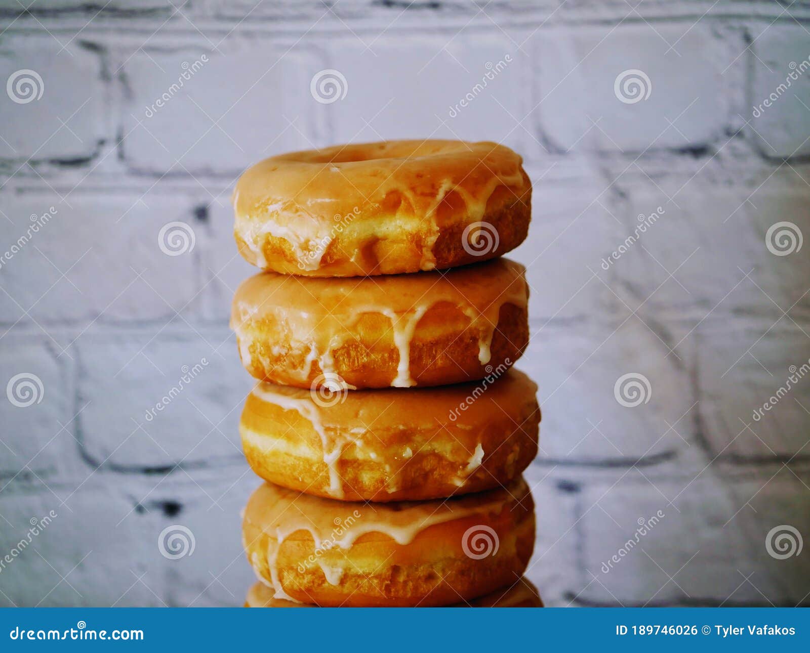 Closeup Stack Of Delicious Glazed Donuts With White Brick Background ...