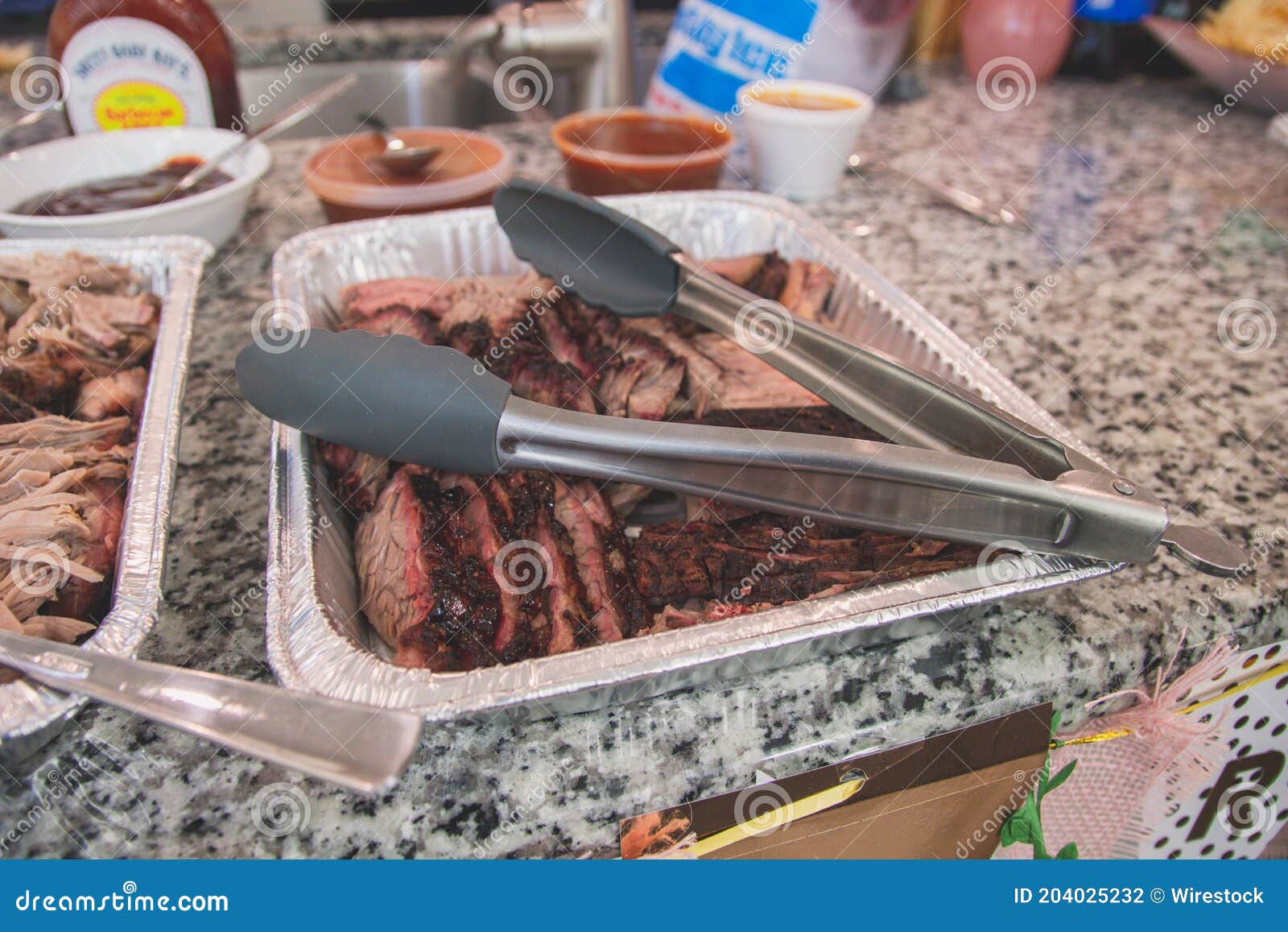 Closeup of Steak Meat with a Tong in a Foiled Container Stock Photo ...