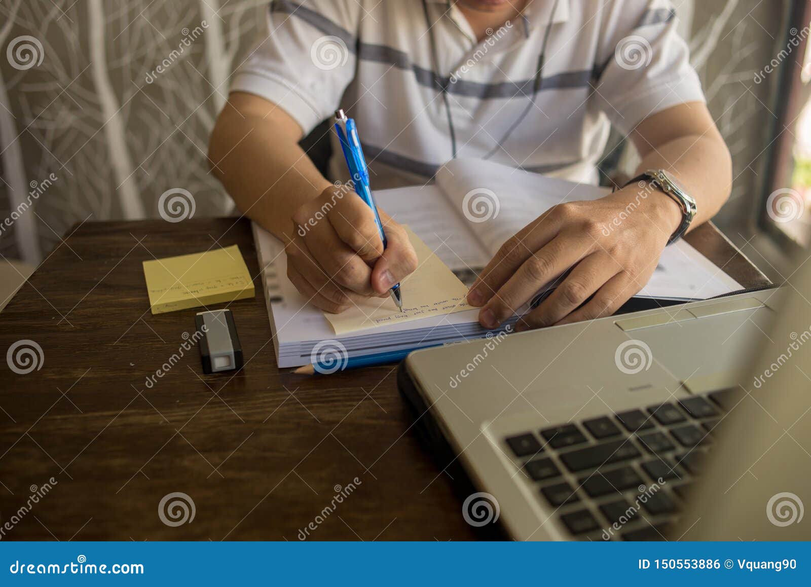 Close Up of Student Doing Homework Next To Laptop Stock Photo - Image ...