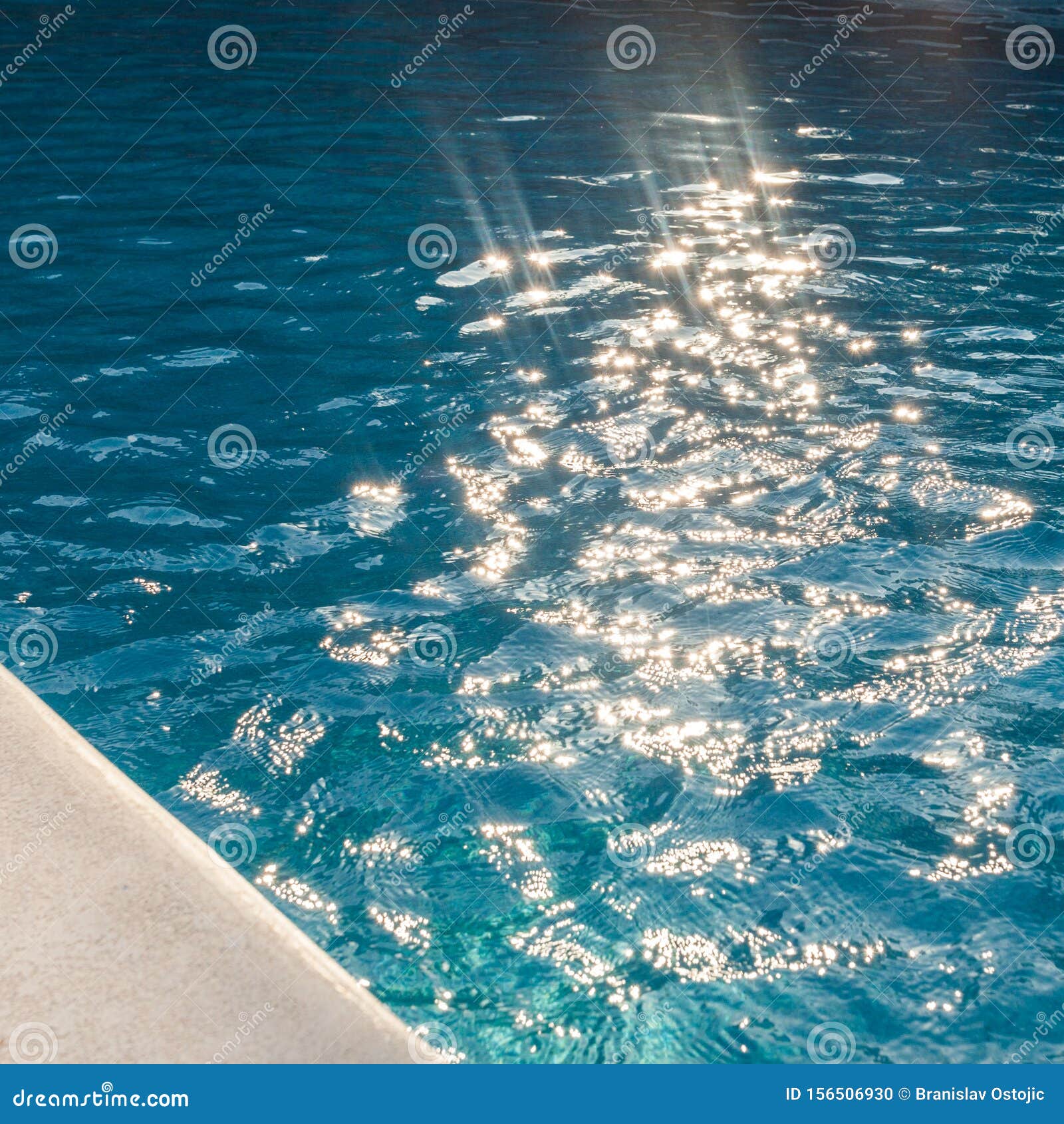 Closeup Of Swimingpool With Clean Blue Water And Sun Rays Summer ...