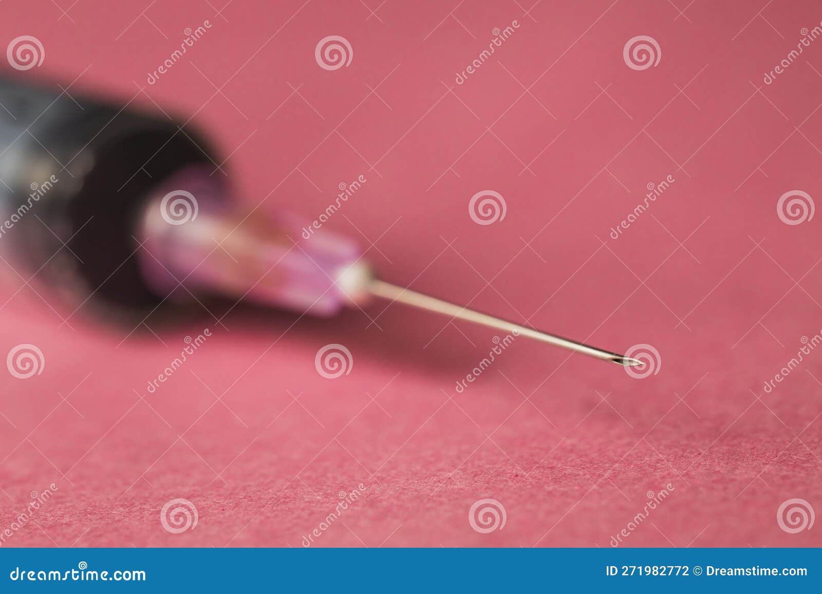 Closeup of a Syringe with a Needle on a Pink Background Stock Photo ...