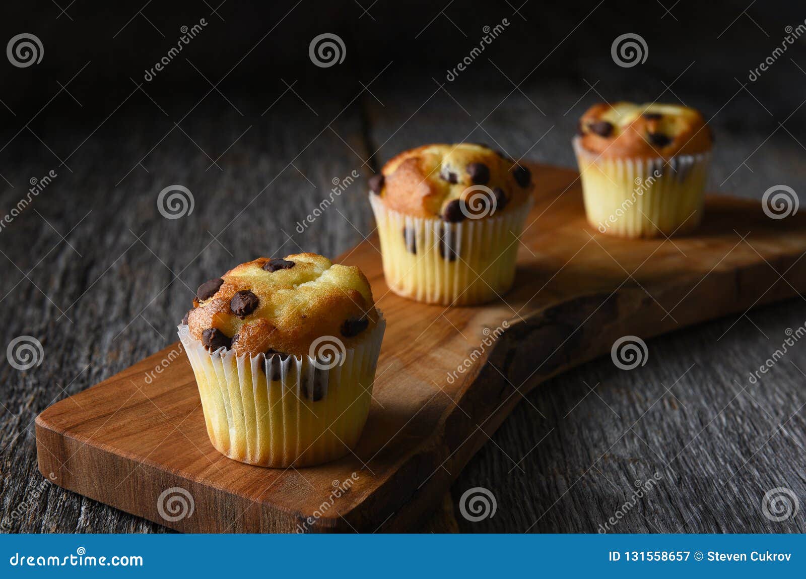 Closeup of Three Mini Chocolate Chip Muffins on a Cutting Board. Stock ...