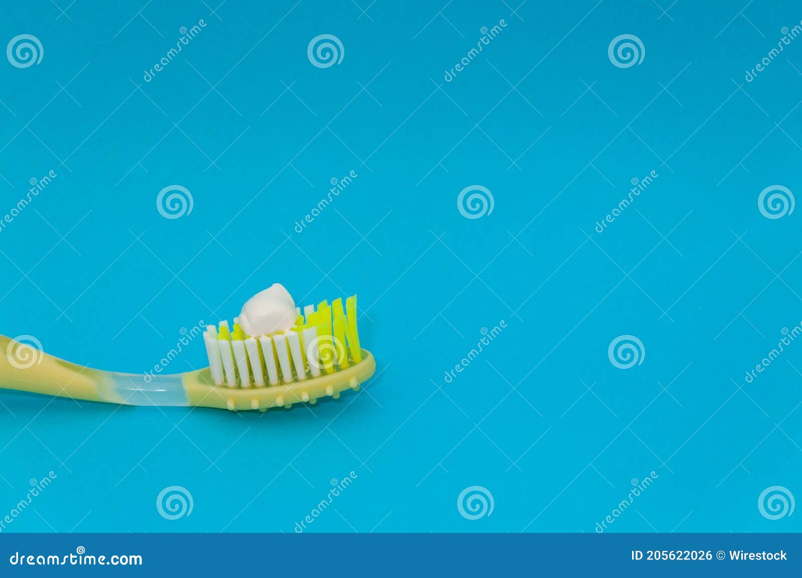 Closeup of Toothpaste Squeezed on a Yellow Toothbrush Isolated on the ...