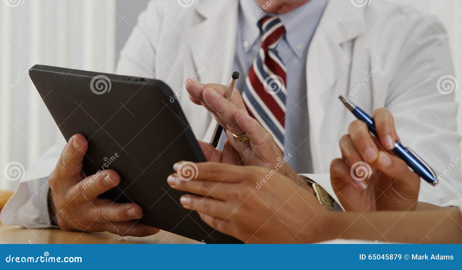 Closeup of Two Doctors Using a Tablet in the Office Stock Image - Image ...