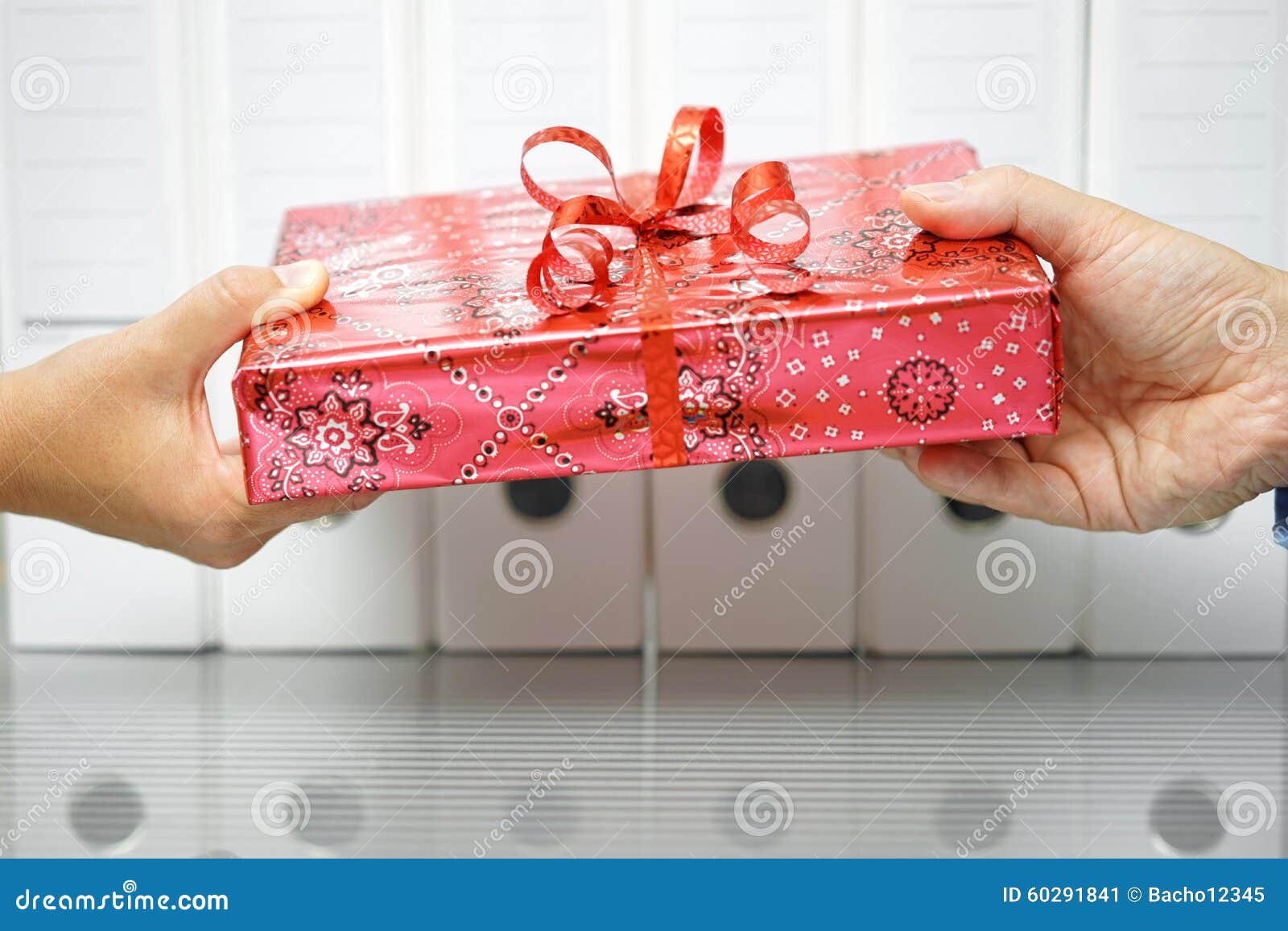 Closeup of Two Hands Exchanging Gift in Office Stock Image - Image of ...