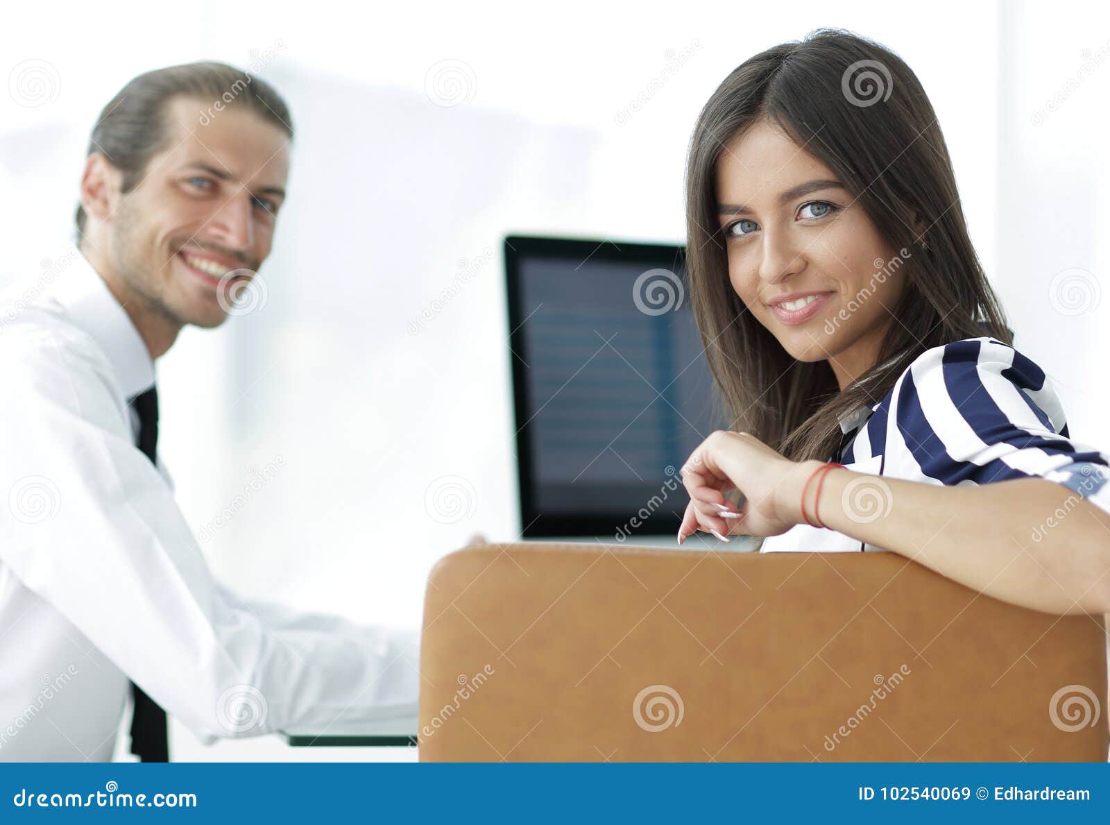 Two Young Employee Sitting Behind a Desk Stock Image - Image of online ...