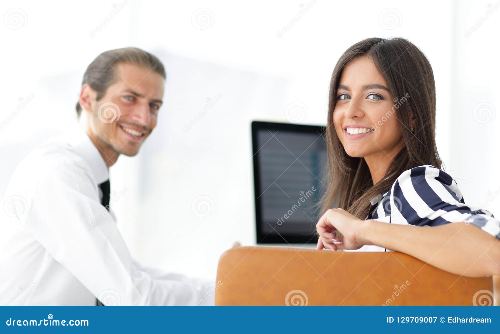 Two Young Employee Sitting Behind a Desk Stock Image - Image of ...