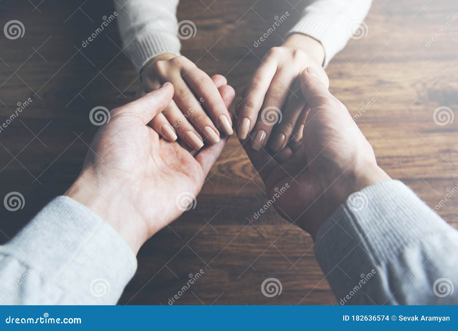 Closeup on Two Young Lovers Holding Hands at a Table Stock Photo ...