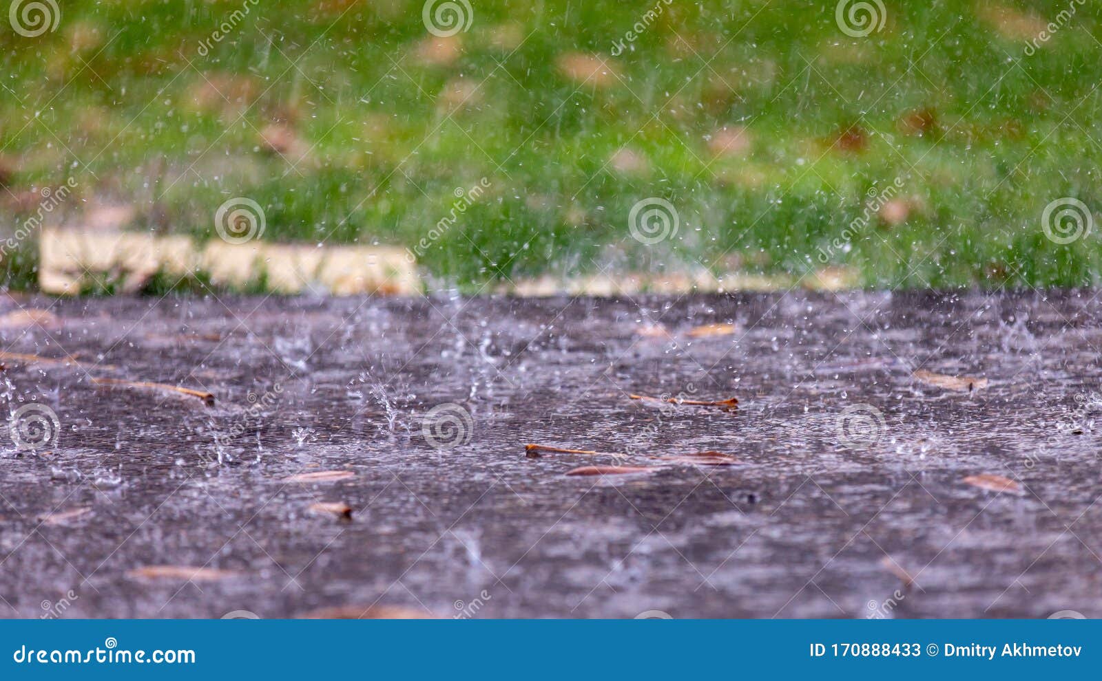 Closeup Up View of a Rain Drops Falling on a Concrete Patio on a ...
