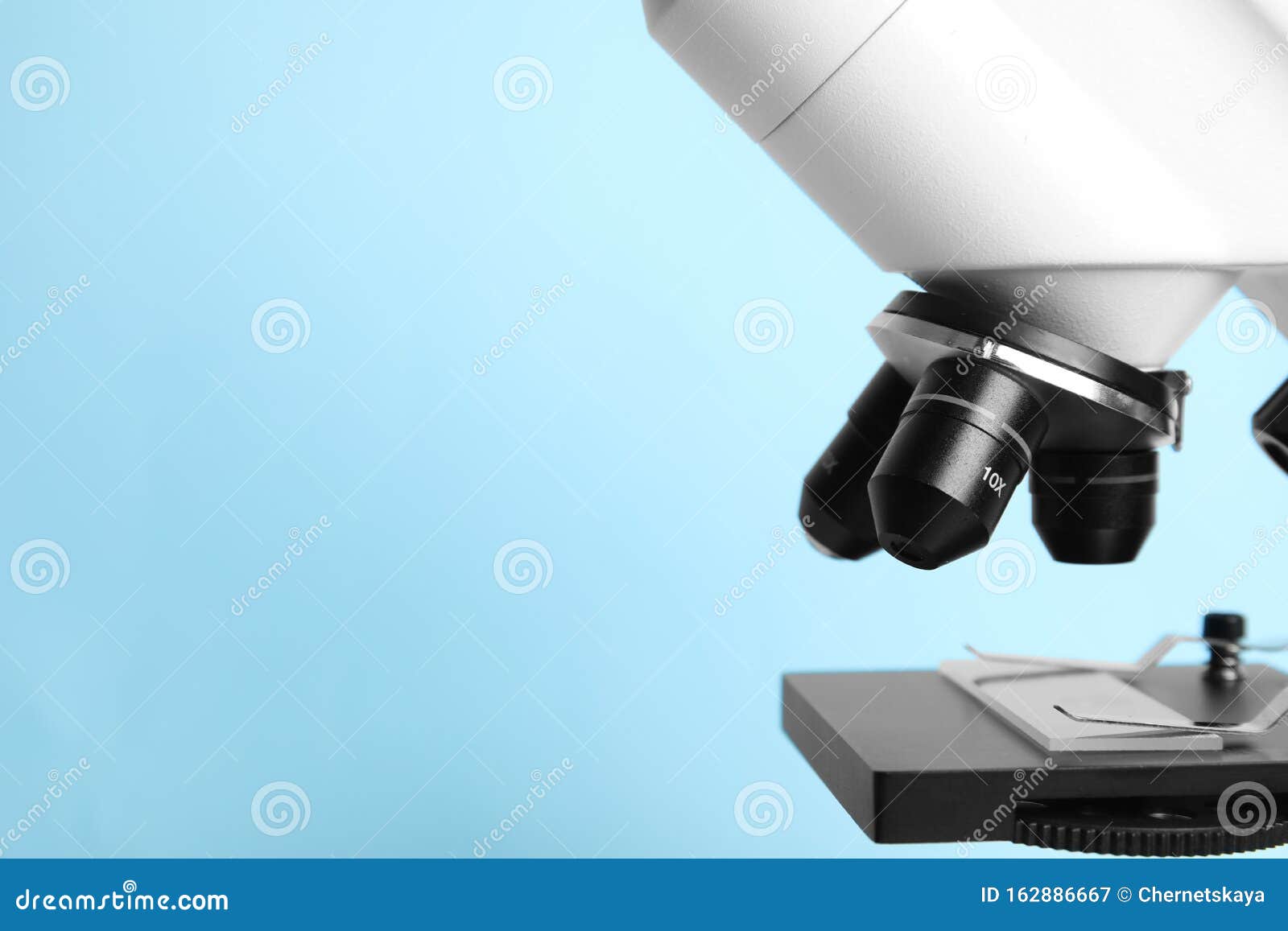 Closeup View of Modern Microscope on Blue Background. Medical Equipment ...