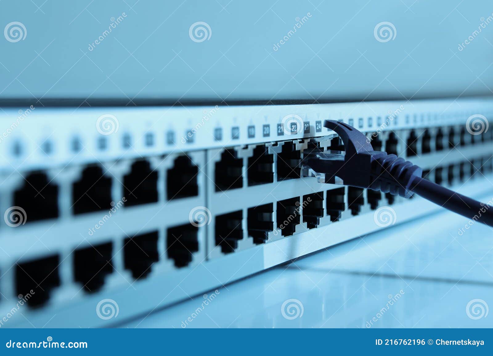 Closeup View of Network Switch with Cable on Light Background, Toned in ...