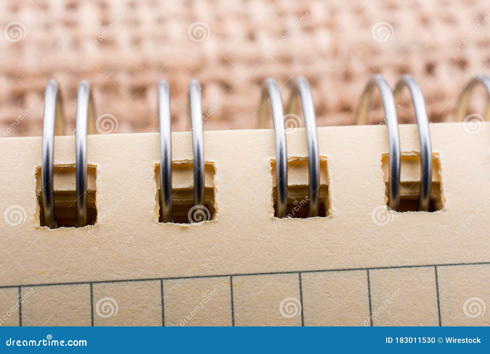 Closeup View of the Wires of a Wired Notebook Captured on a Brown ...