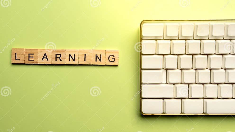 Closeup View of a Wooden Cube with Learning Word and Computer Keyboard ...