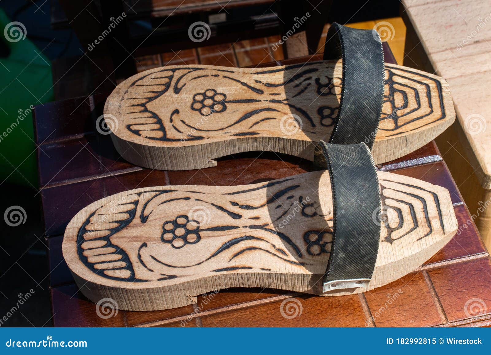 Closeup View of Wooden Slippers with a Design on a Brown Surface Stock ...